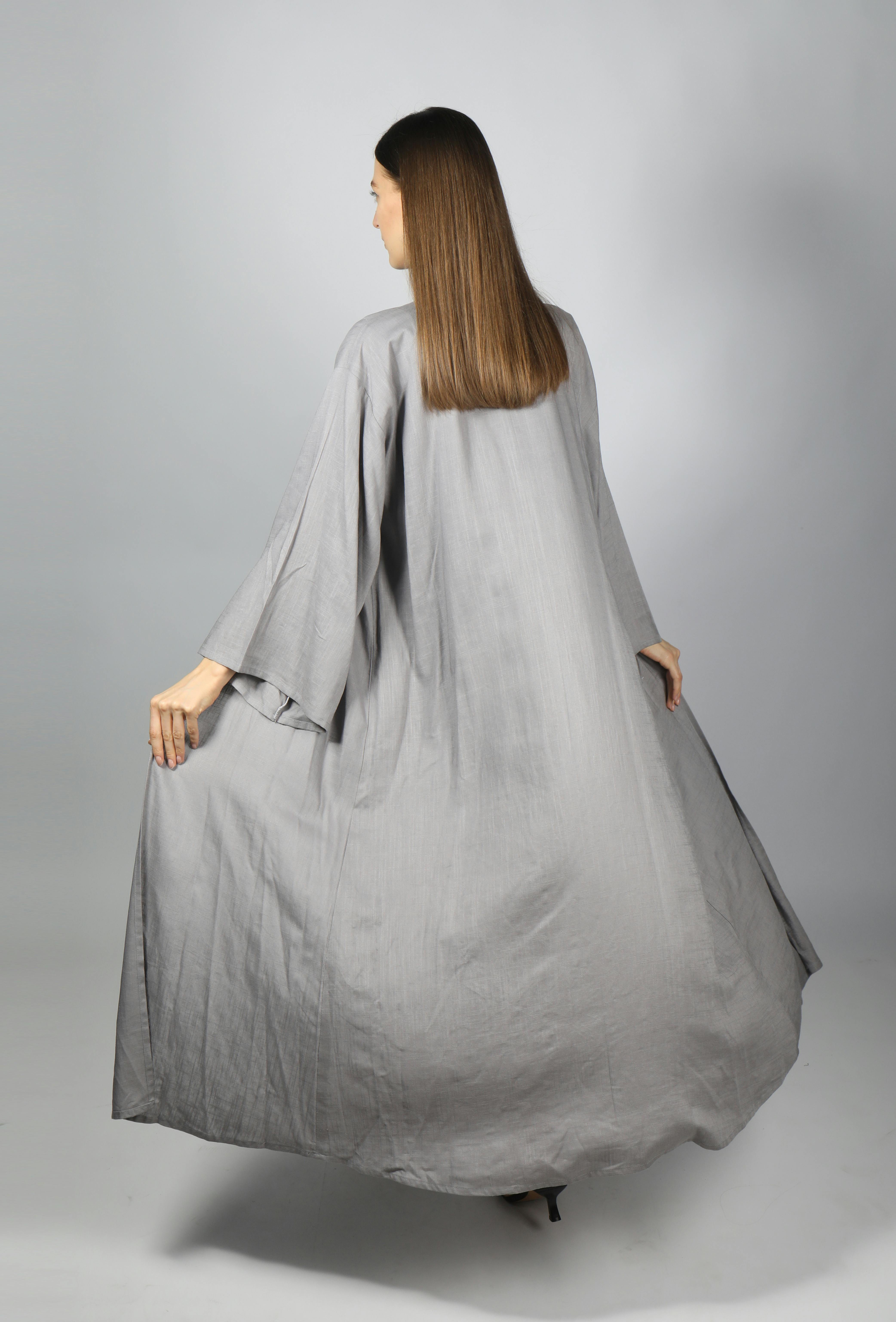 Back View of a Woman Wearing a Gray Cloak · Free Stock Photo