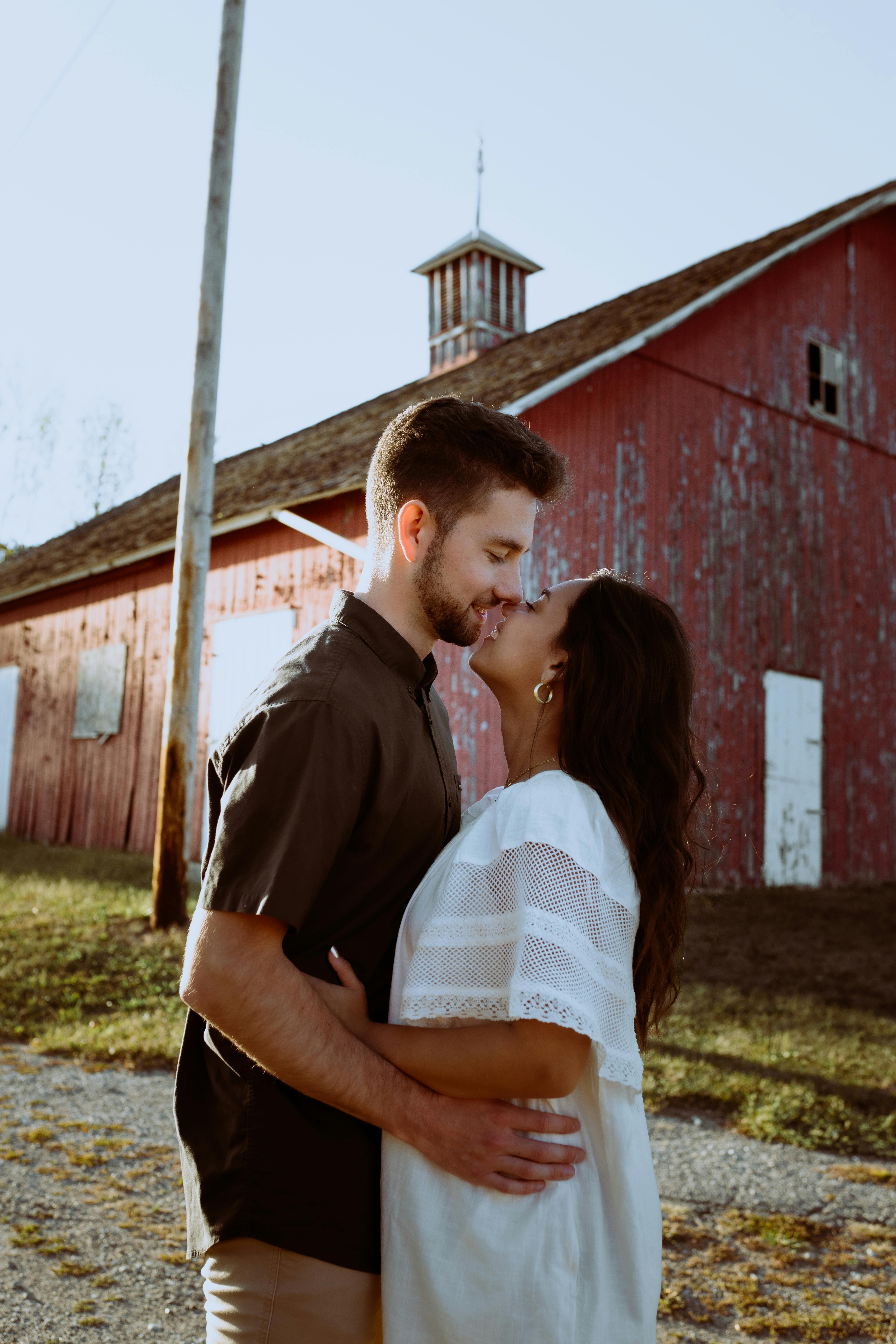 Man in Black Polo Kissing Woman in White Dress · Free Stock Photo