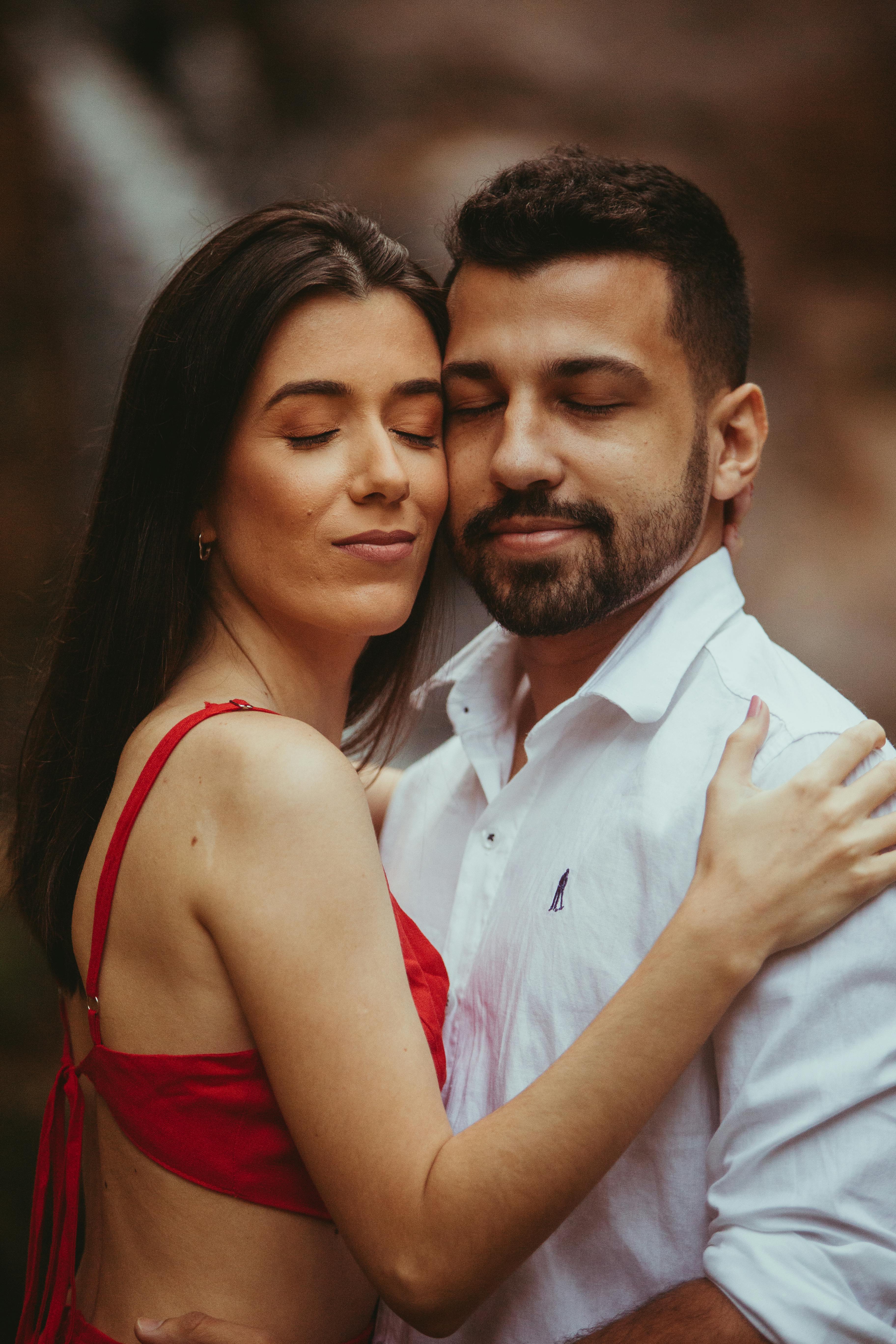 Man in White Dress Shirt Hugging Woman in Red Tank Top · Free Stock Photo