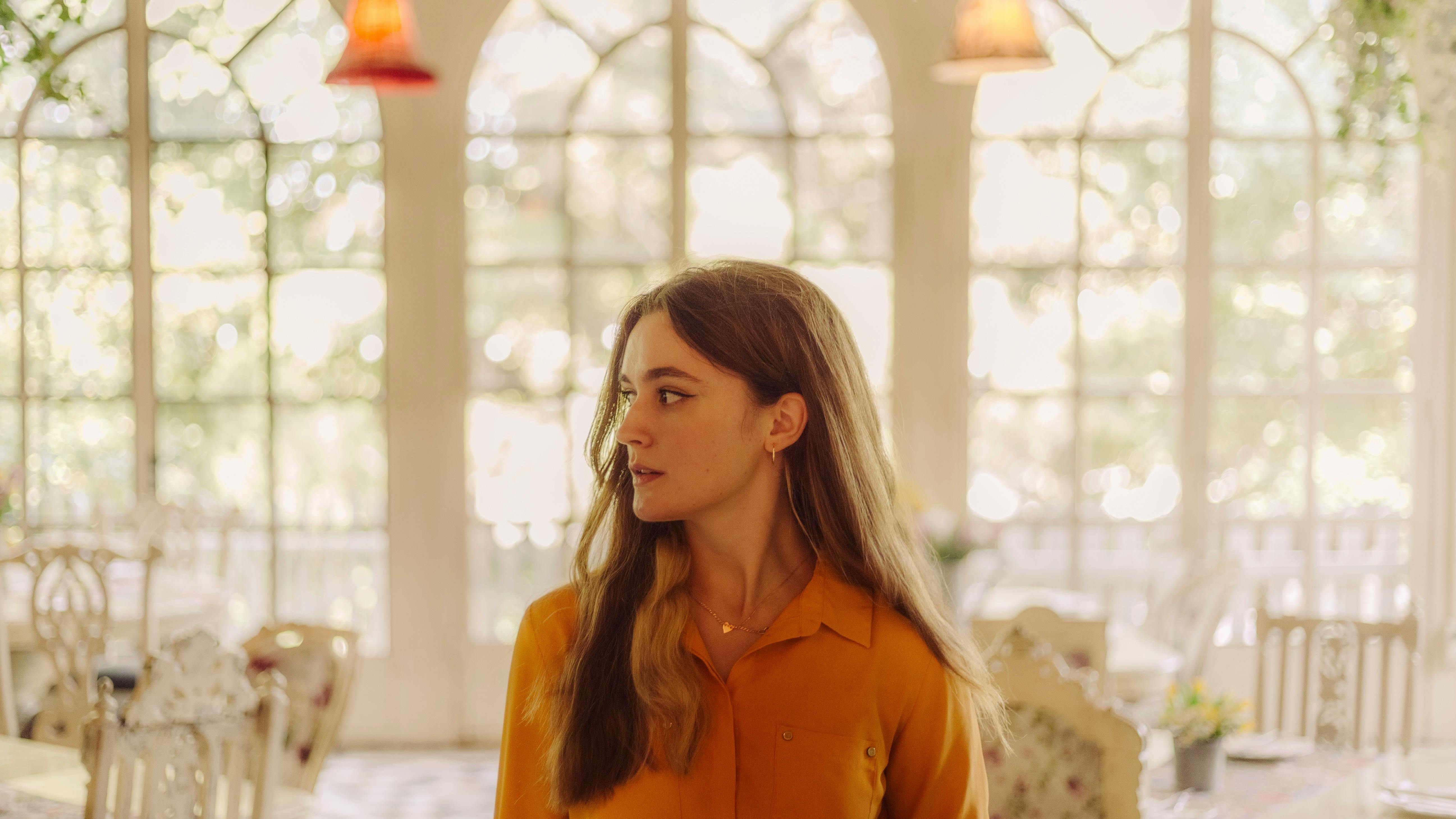 Portrait of woman posing in large doll box · Free Stock Photo