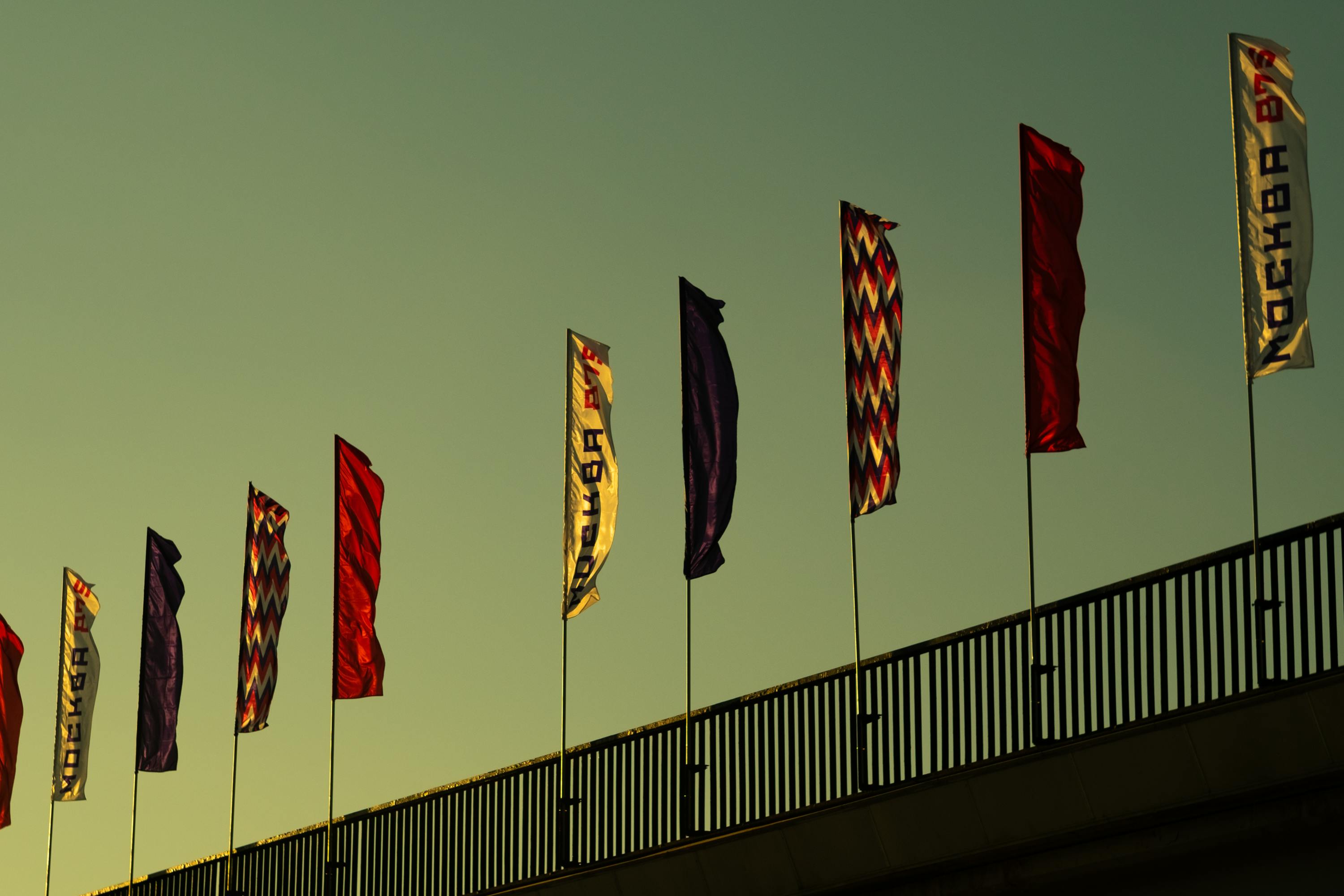 Low Angle Shot of Flags Swaying by the Wind · Free Stock Photo