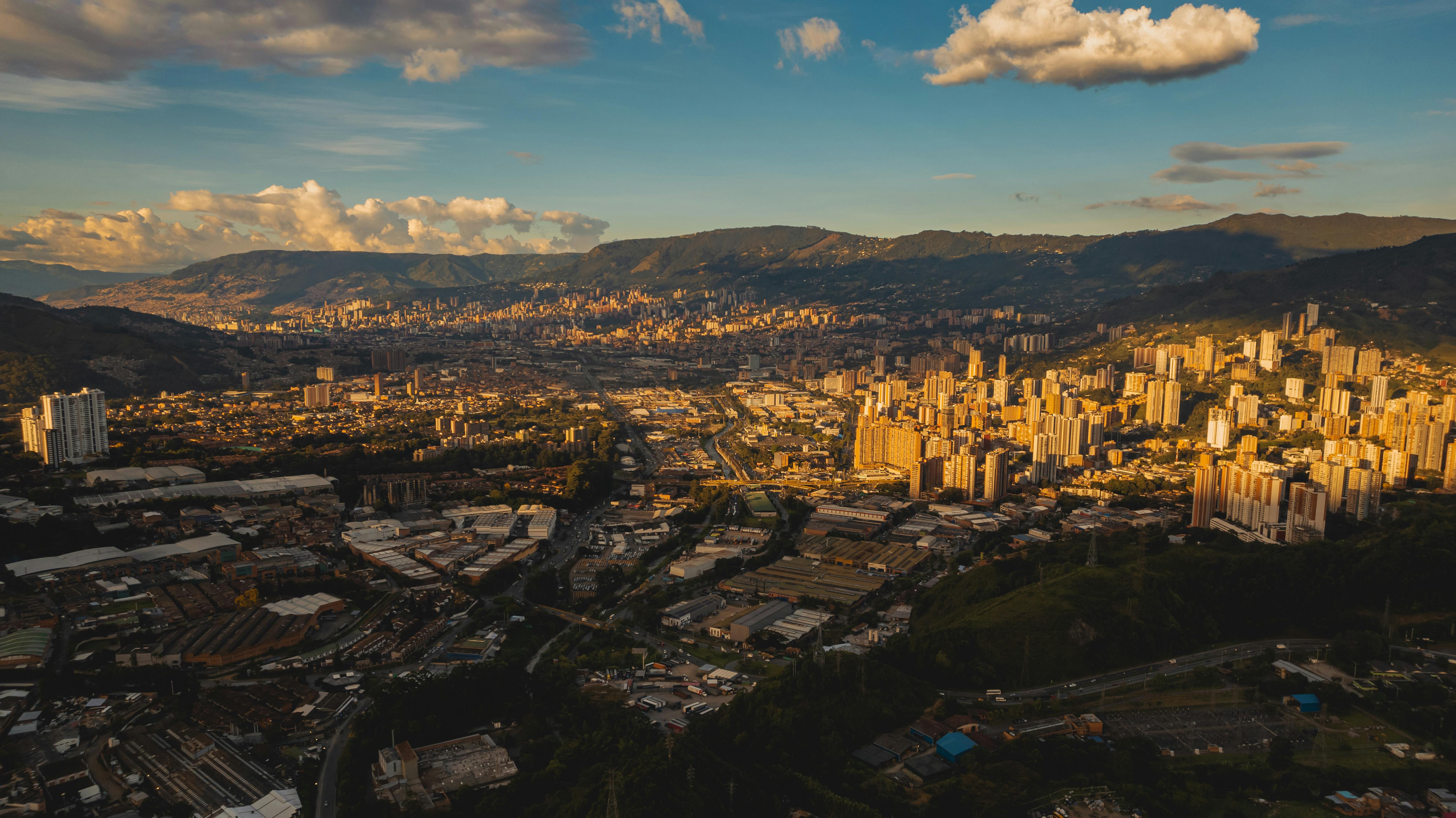 High Rise Buildings in a City Near Mountain Range · Free Stock Photo