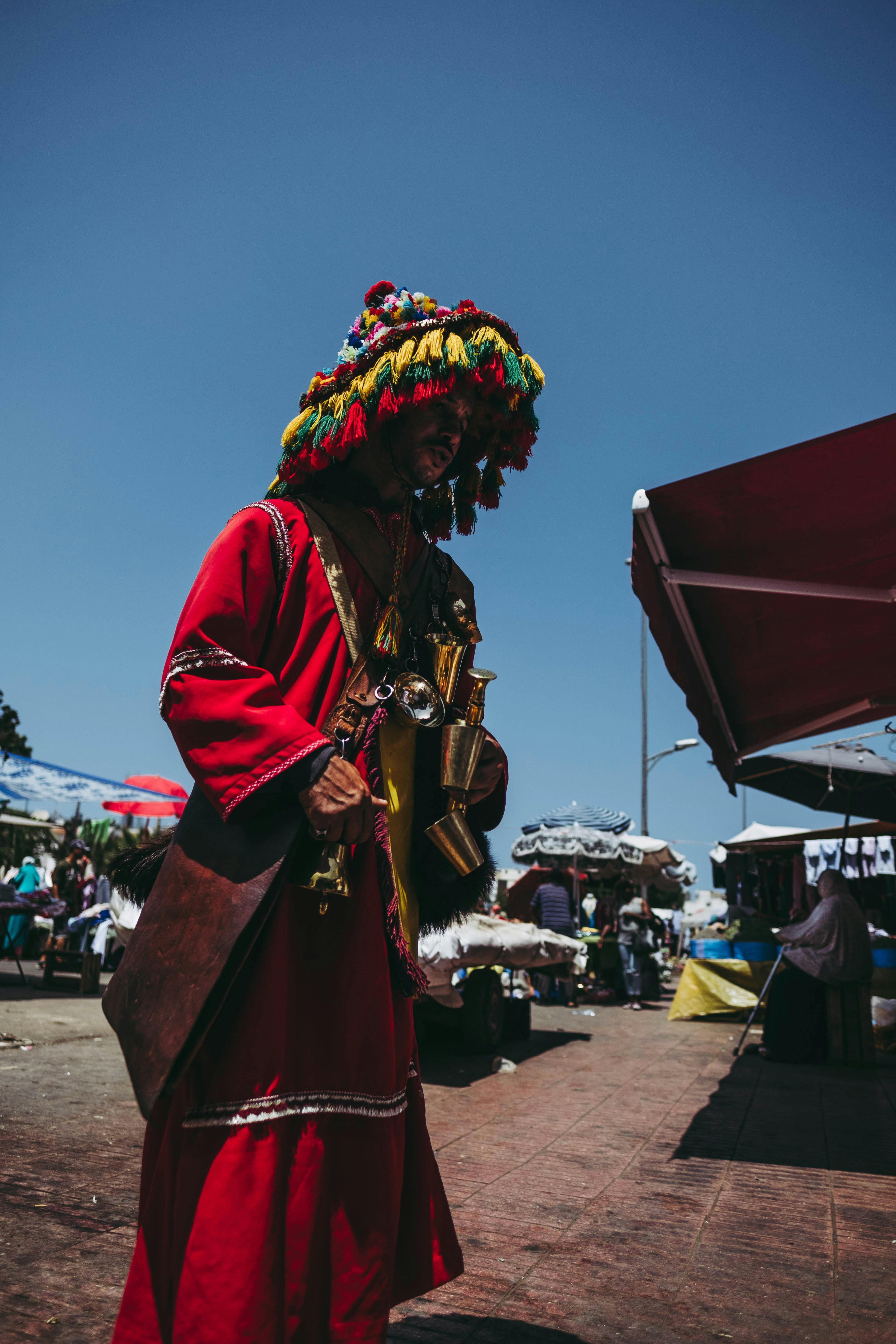 Man Wearing Red Robe With Headdress Near Awning · Free Stock Photo