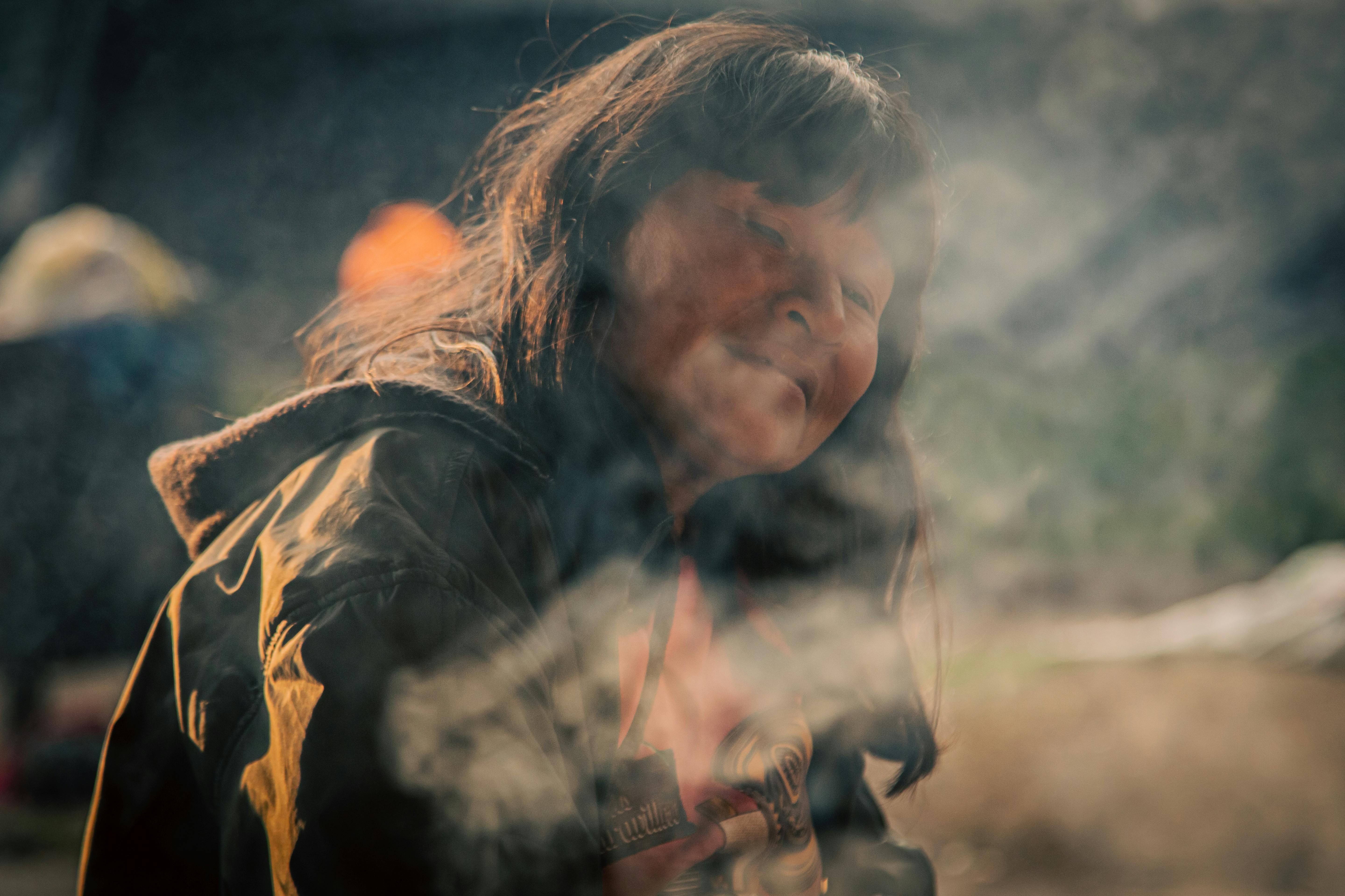 Smoke all around of Smiling Woman · Free Stock Photo