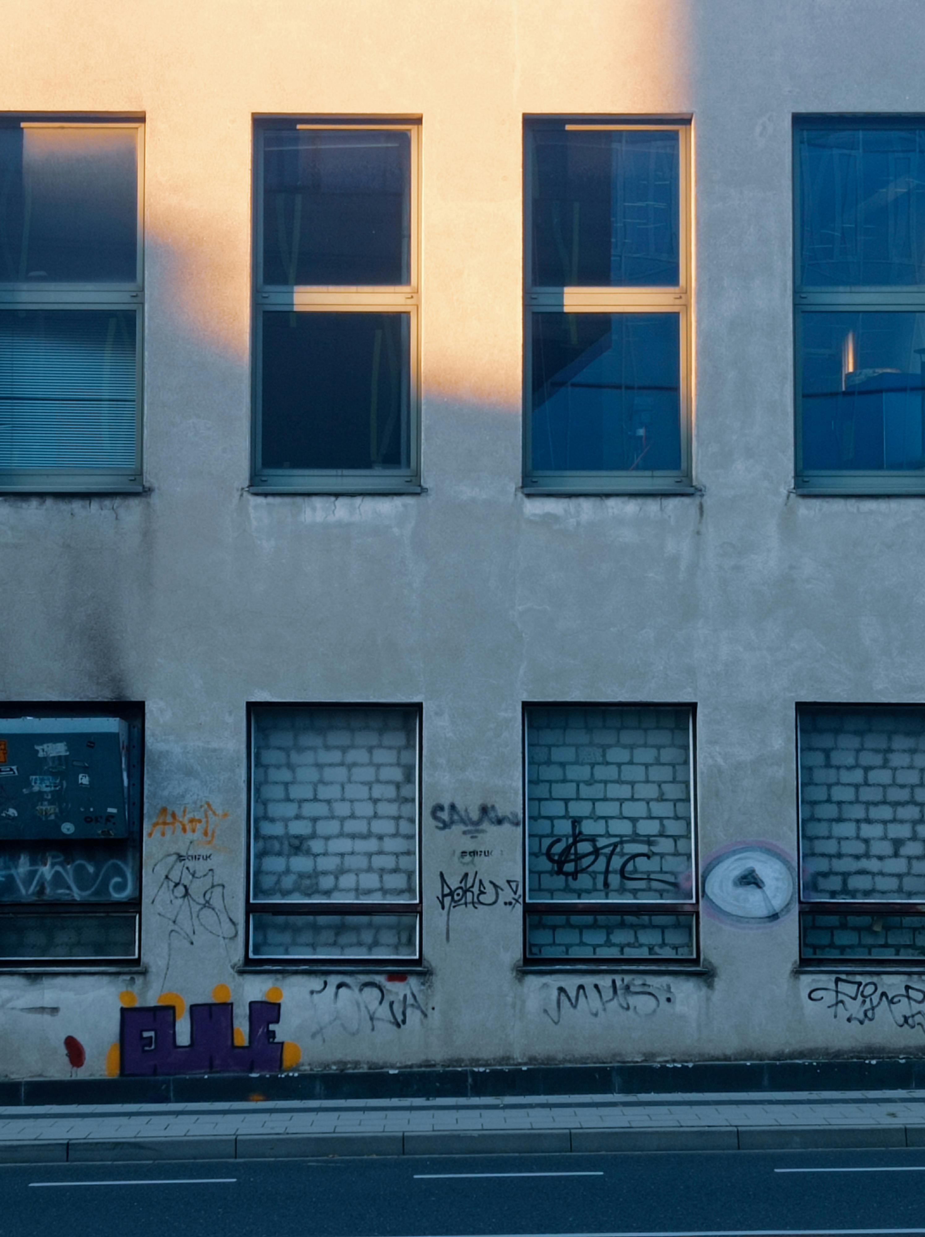 Empty Road Between Concrete Houses Under Blue Sky · Free Stock Photo