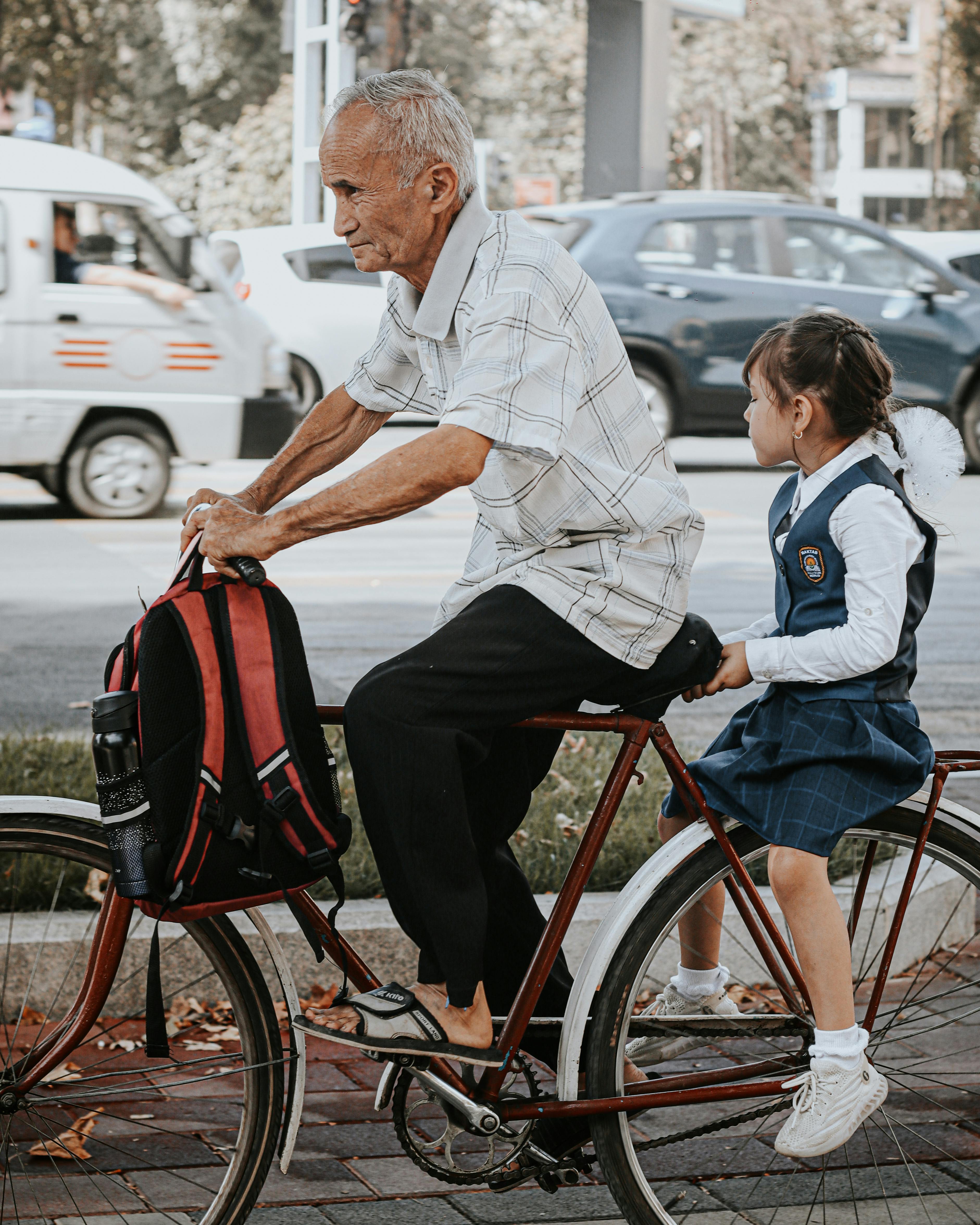 An Elderly Man and Young Girl Riding a Bicycle · Free Stock Photo
