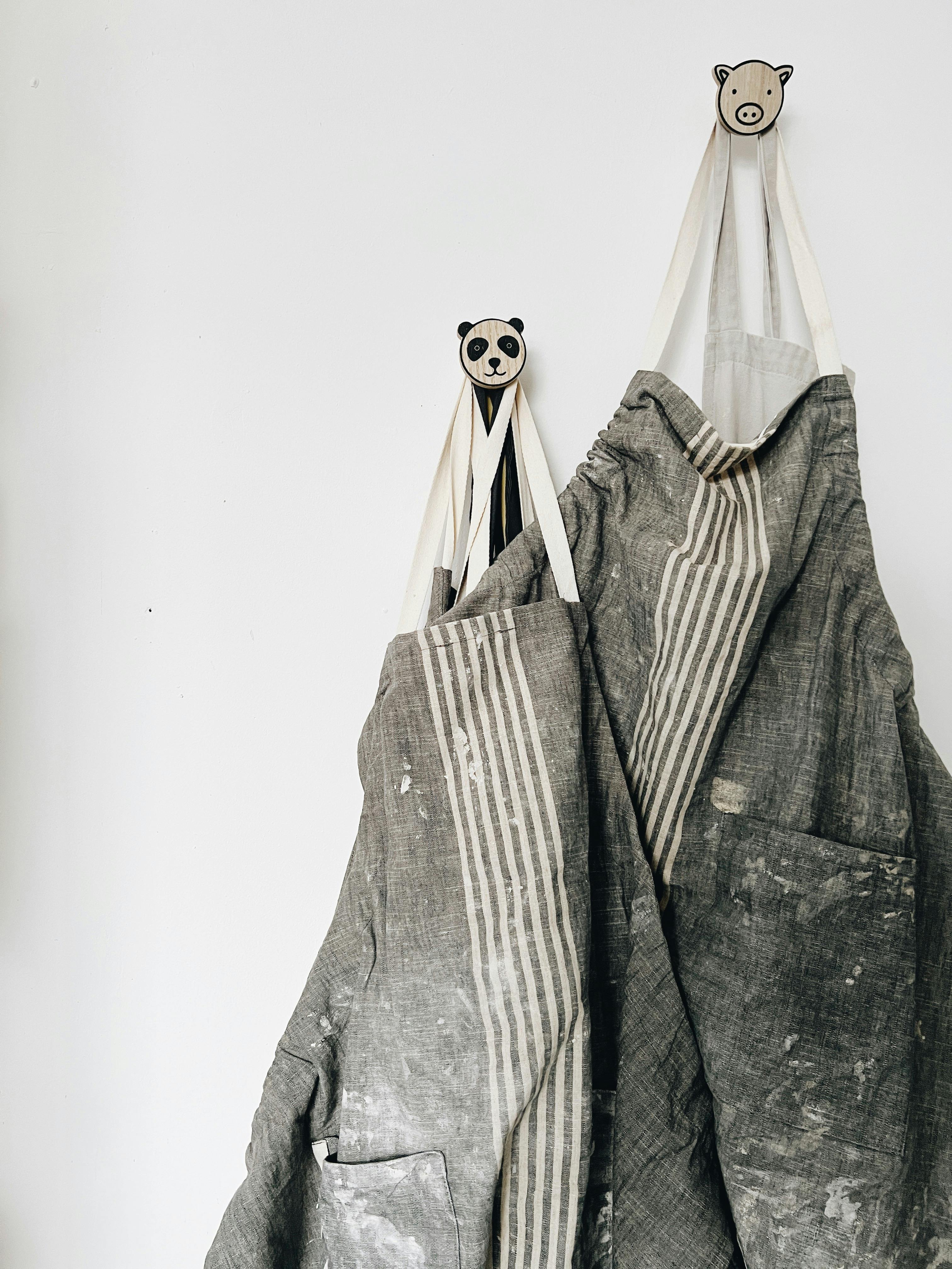 Two Aprons Hanging on a Wall · Free Stock Photo