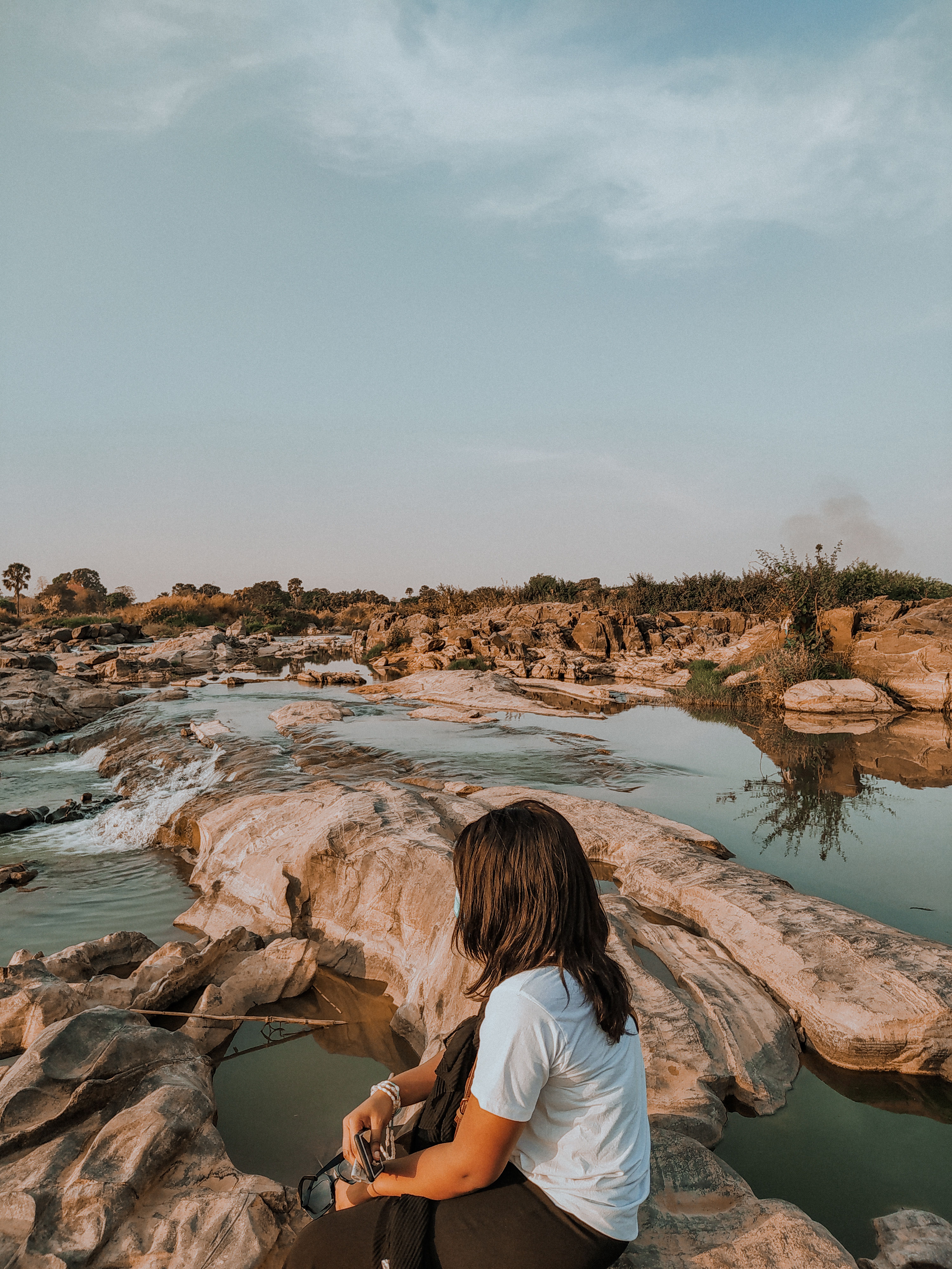 Person Sitting on Rock at Golden Hour · Free Stock Photo