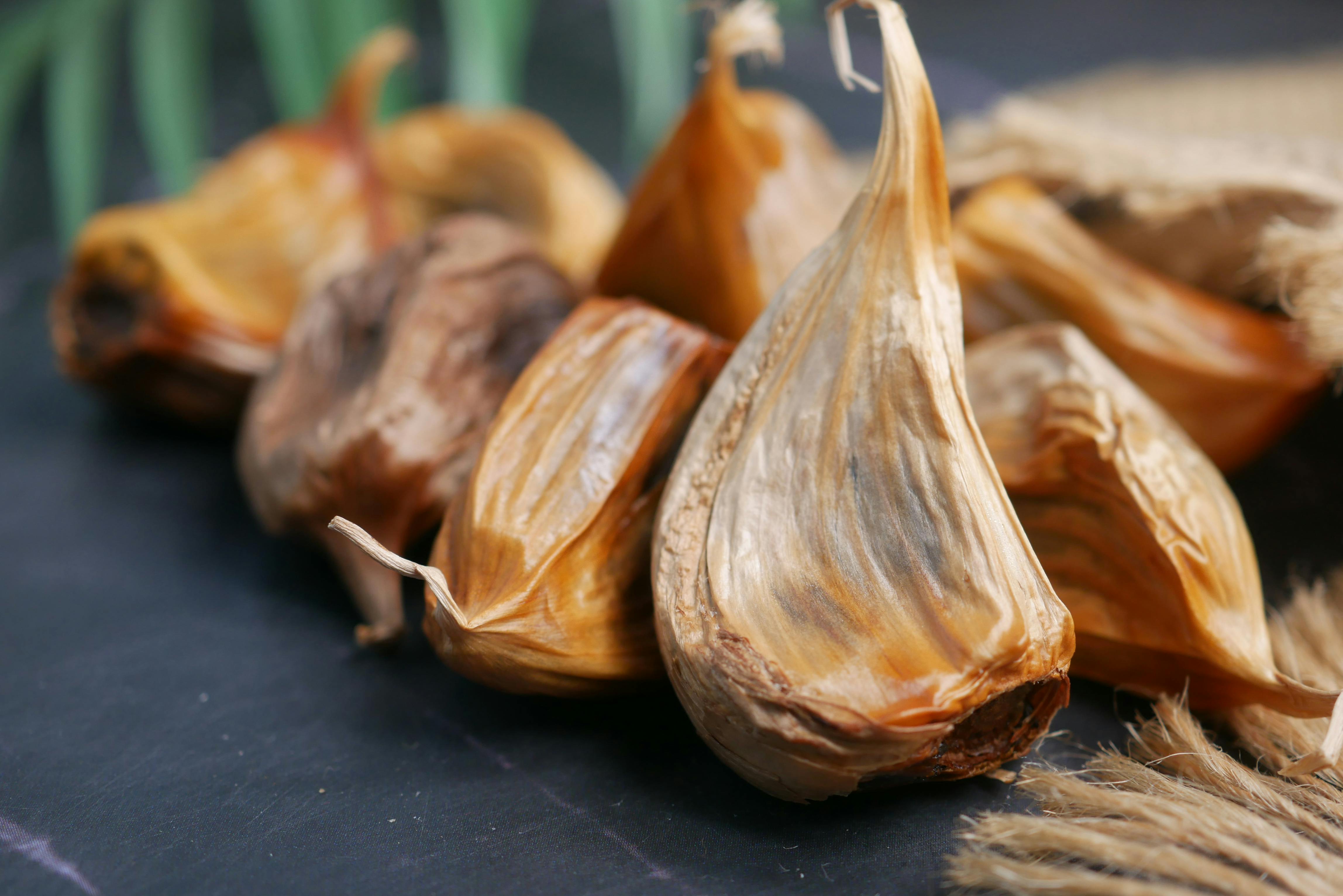 Garlic Bulbs on Brown Surface · Free Stock Photo
