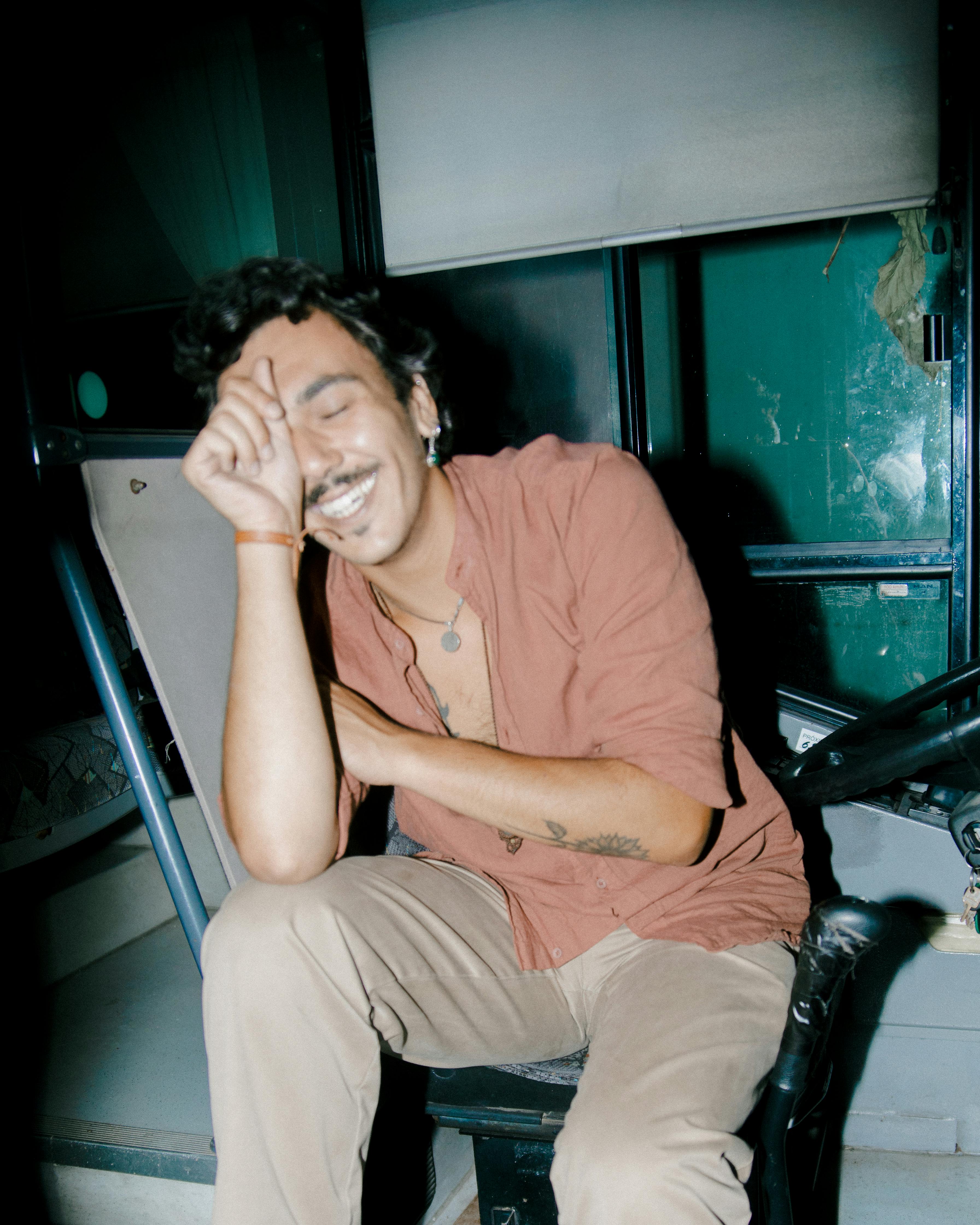 Smiling Man Sitting · Free Stock Photo