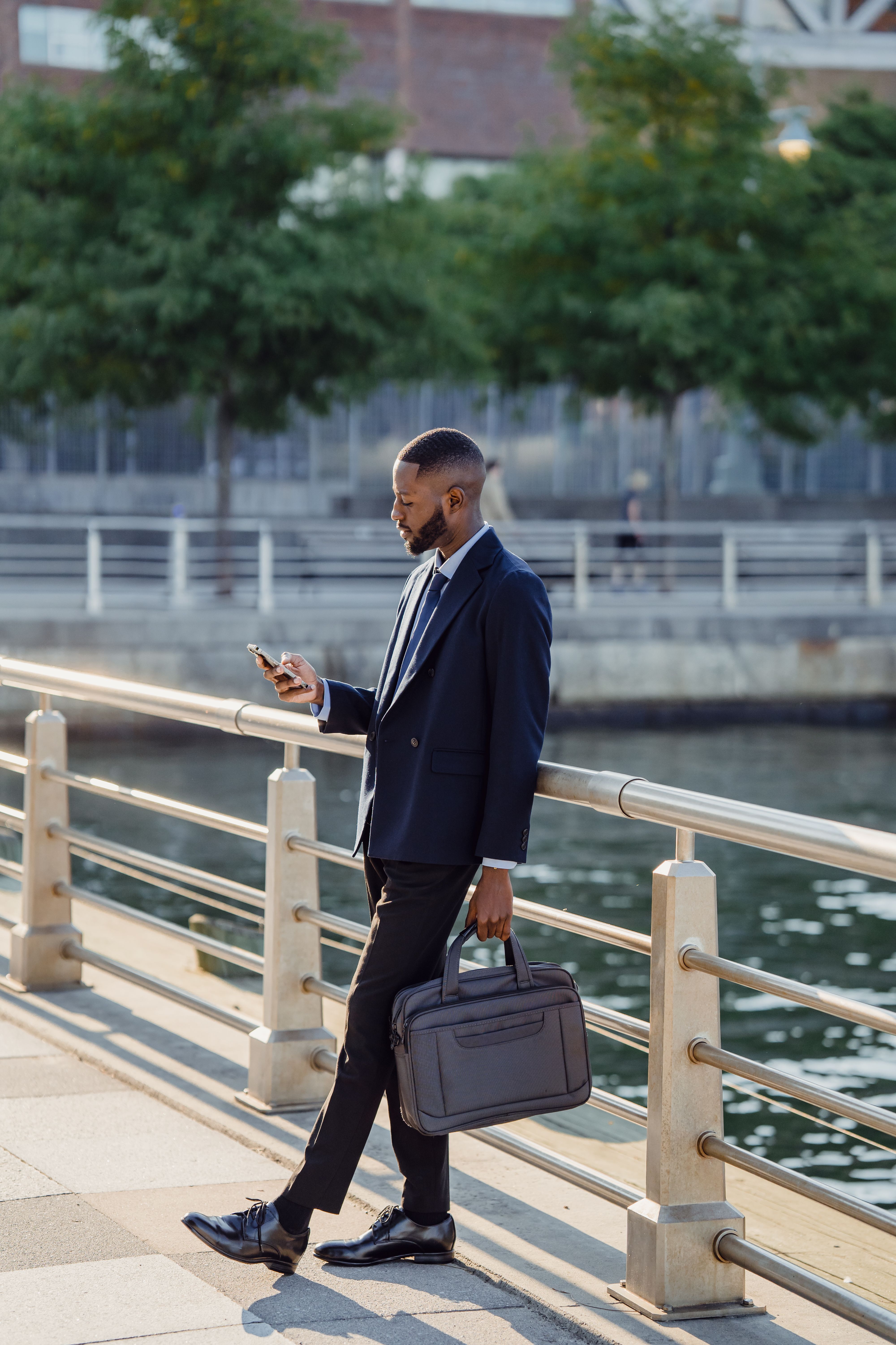 A Man Standing with a Smart Phone · Free Stock Photo