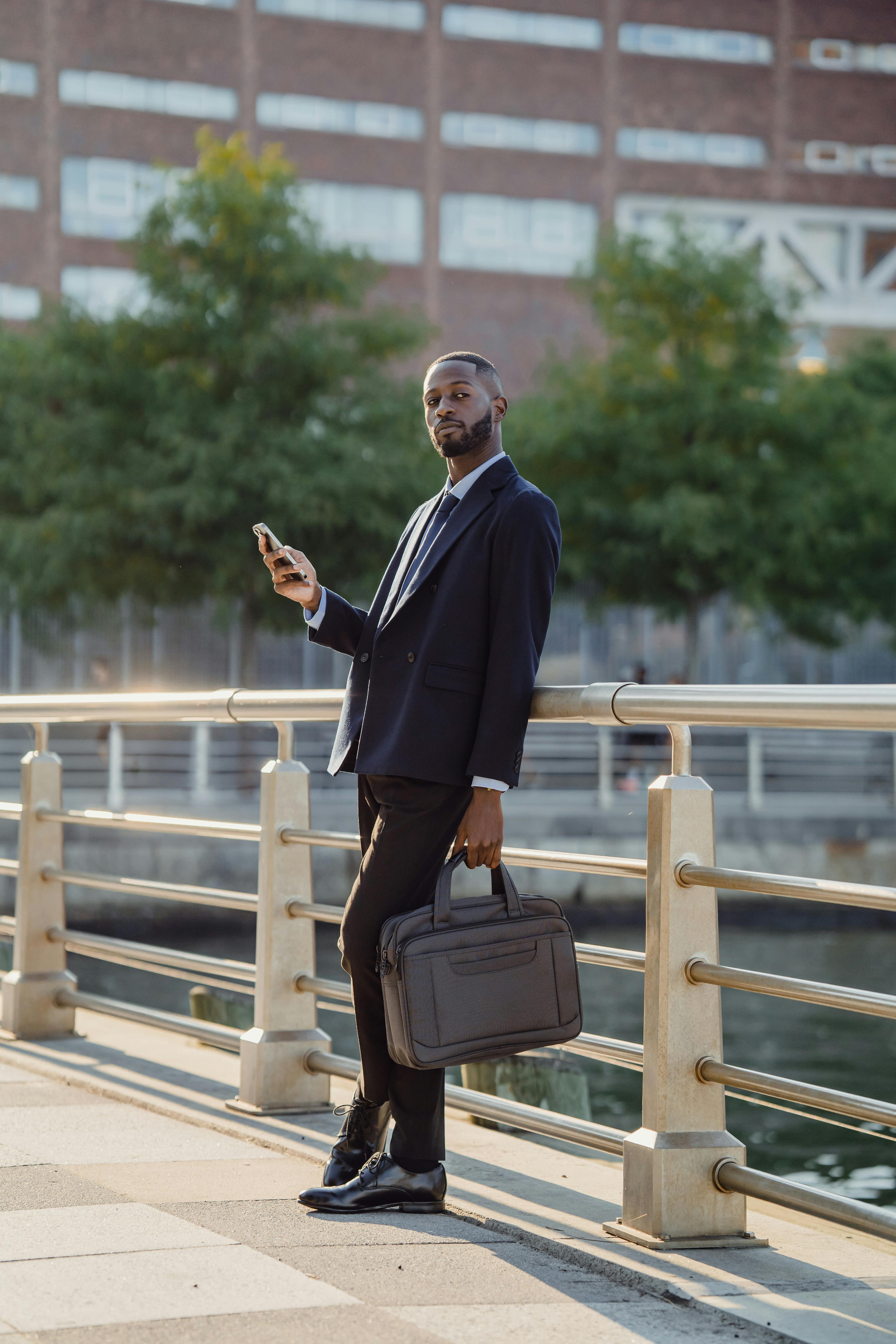 A Man in a Suit Using a Smart Phone · Free Stock Photo