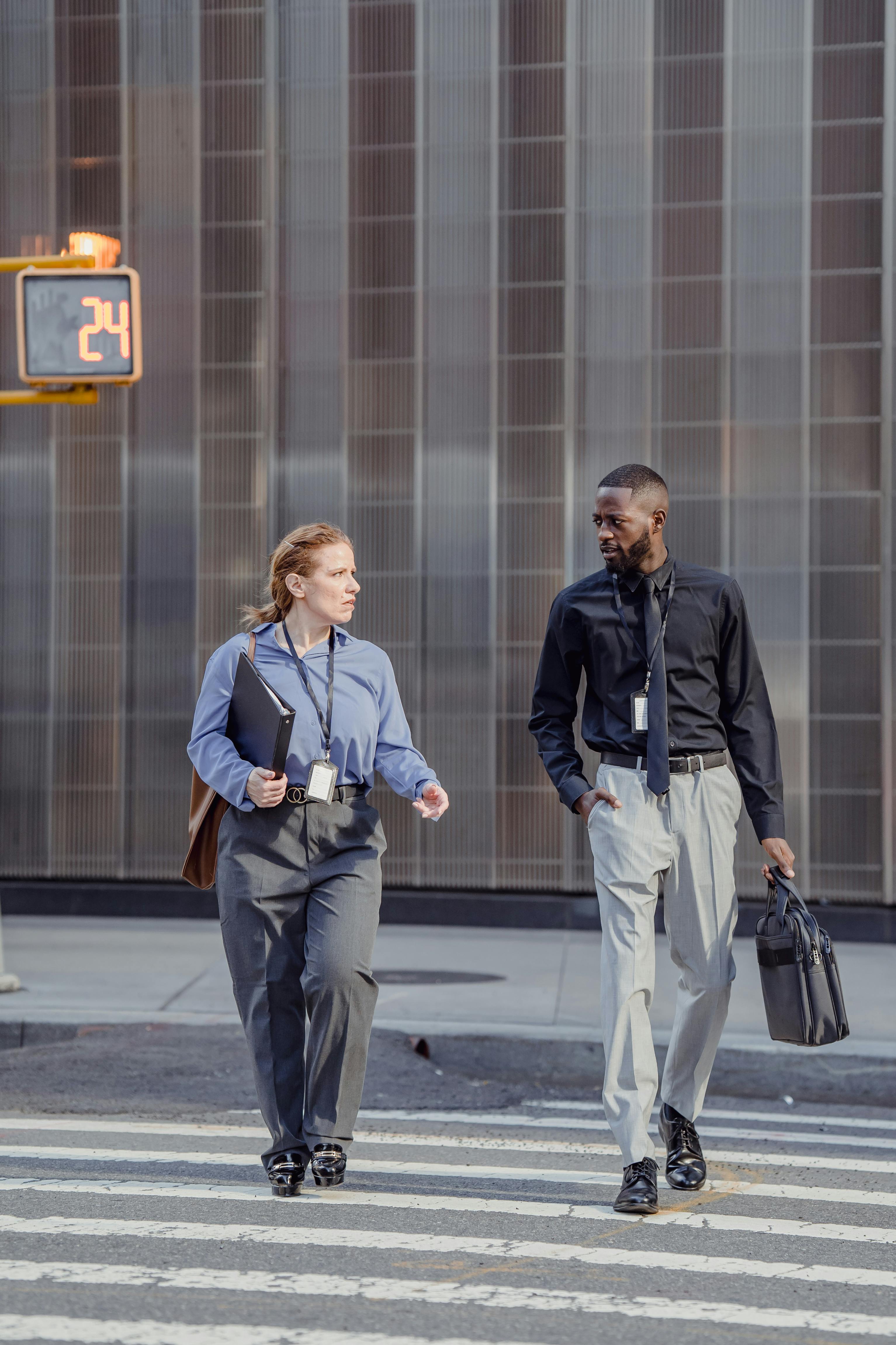 Two People Talking while Crossing the Street · Free Stock Photo