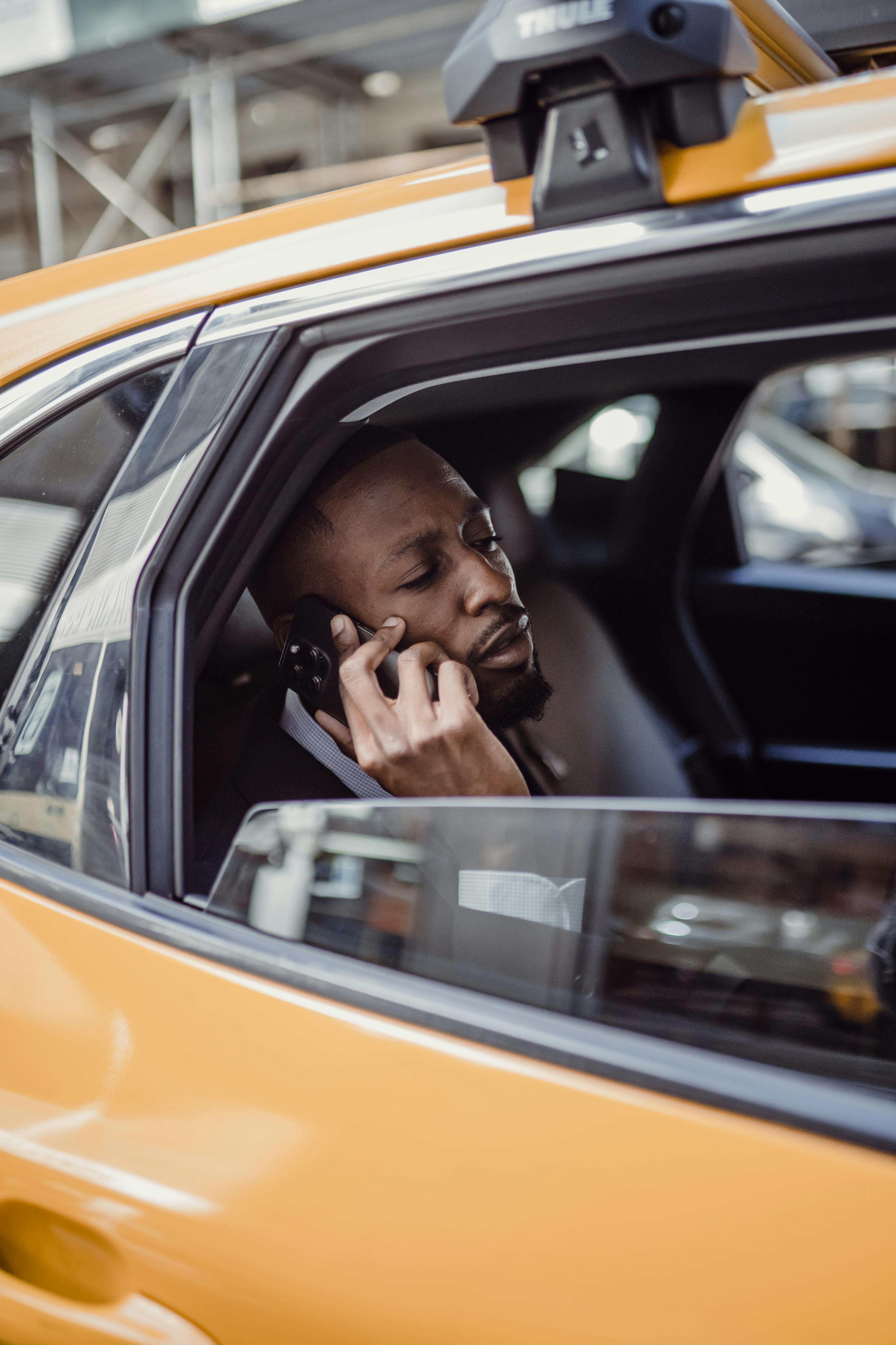 Man Sitting in a Taxi and Talking on the Phone · Free Stock Photo