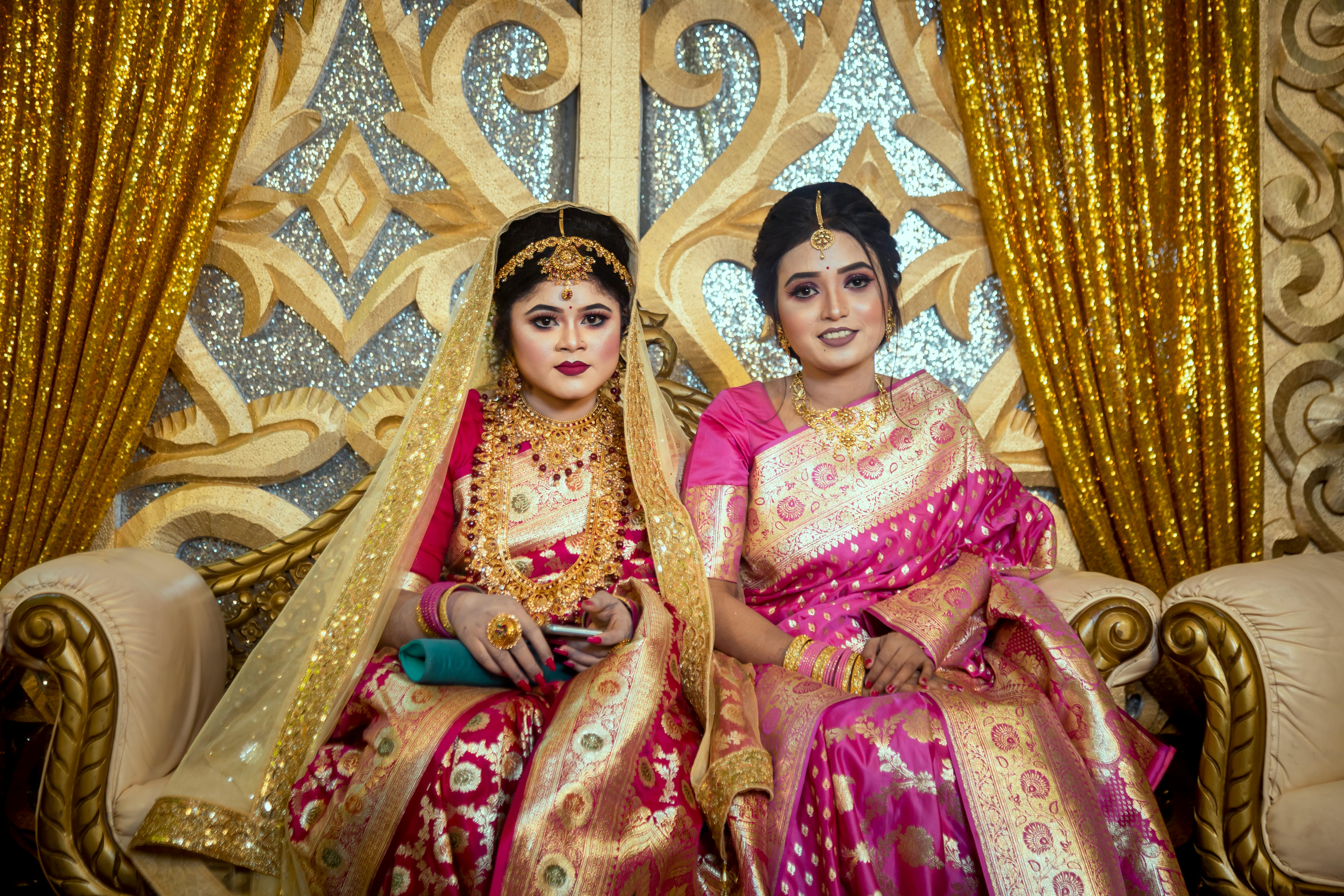 Pretty Women in Traditional Dress Sitting on a Sofa · Free Stock Photo