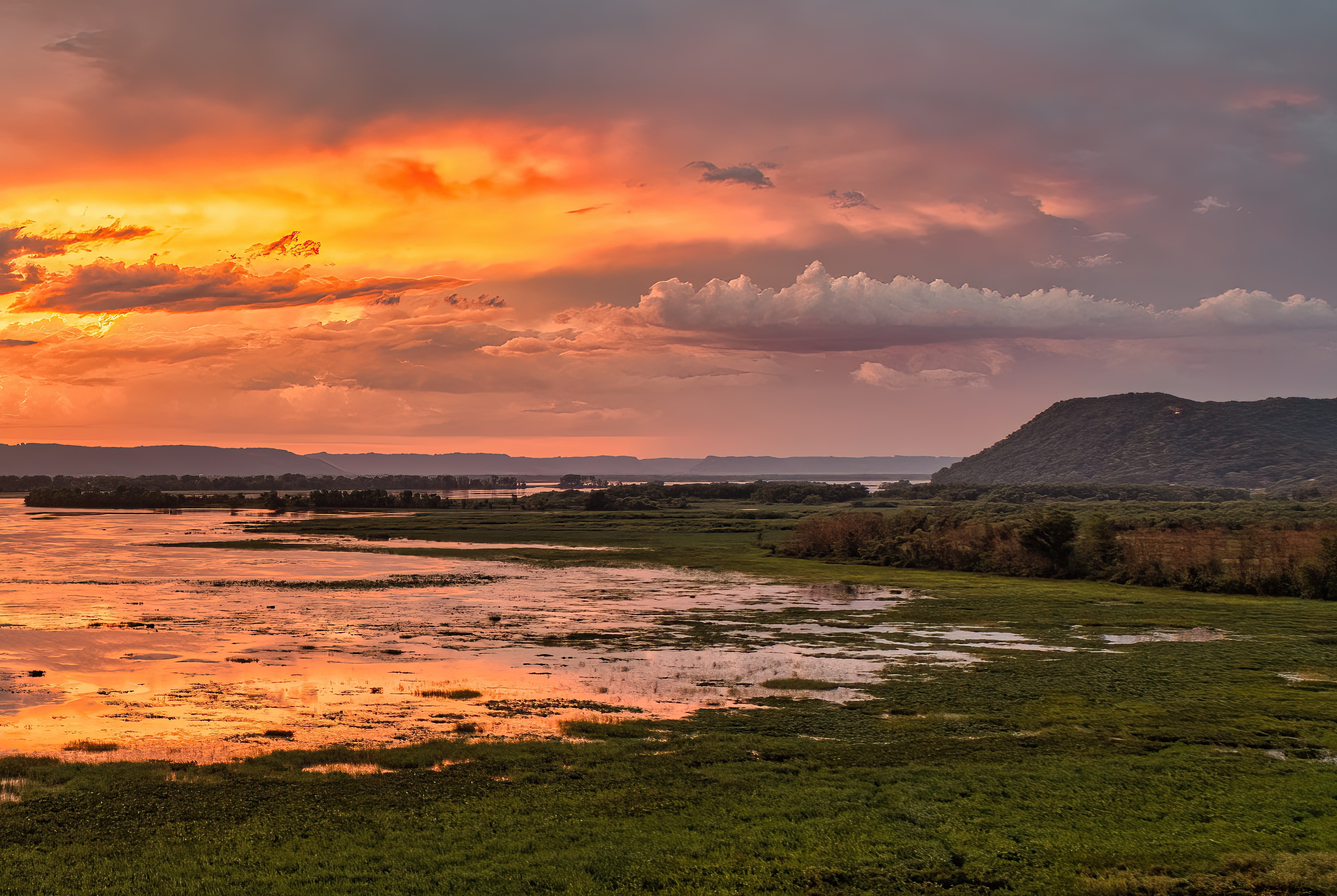 Pink Sky over a Wetland and Hills in Distance · Free Stock Photo