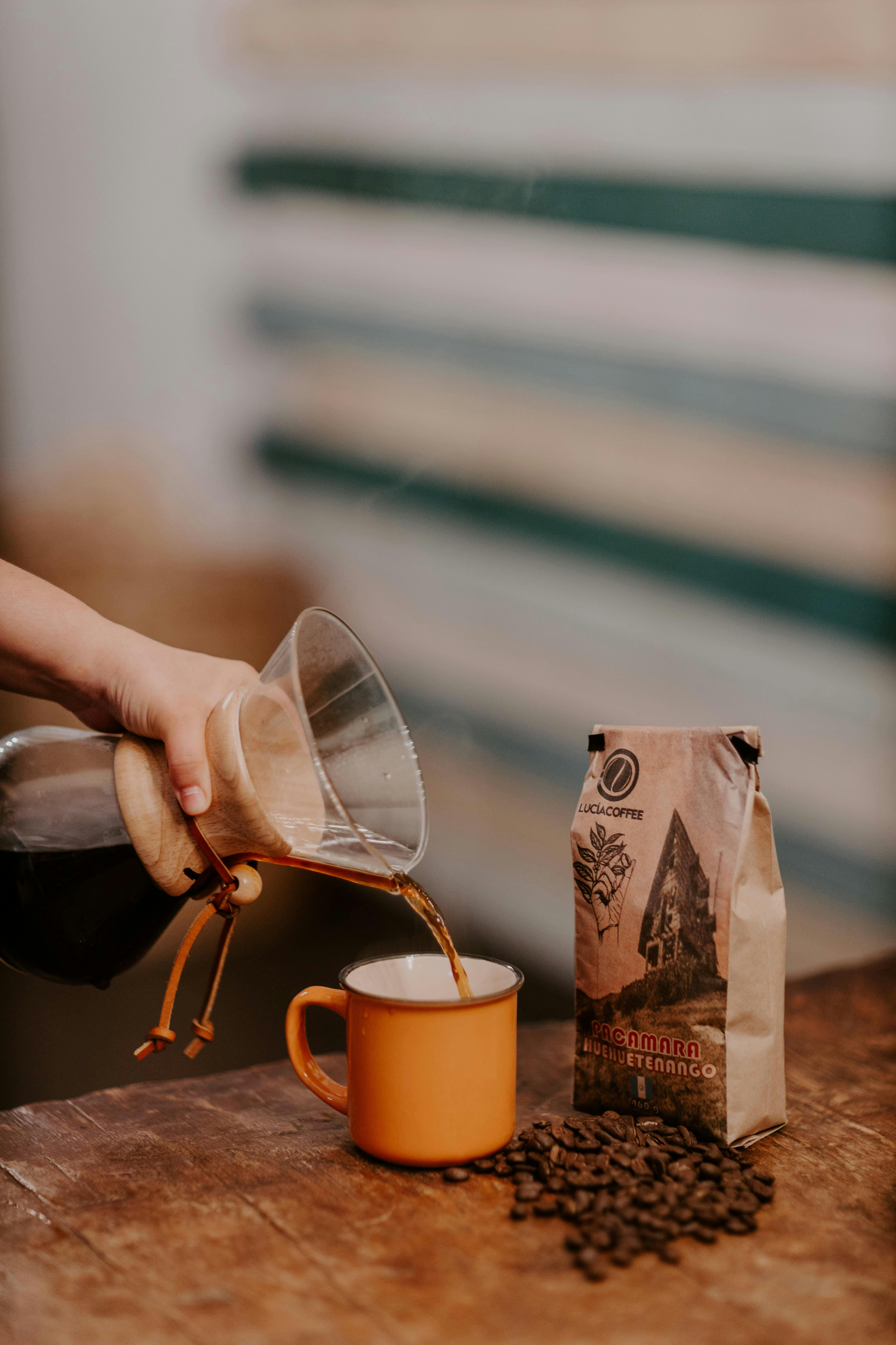 Woman Hand Pouring Coffee into Cup · Free Stock Photo