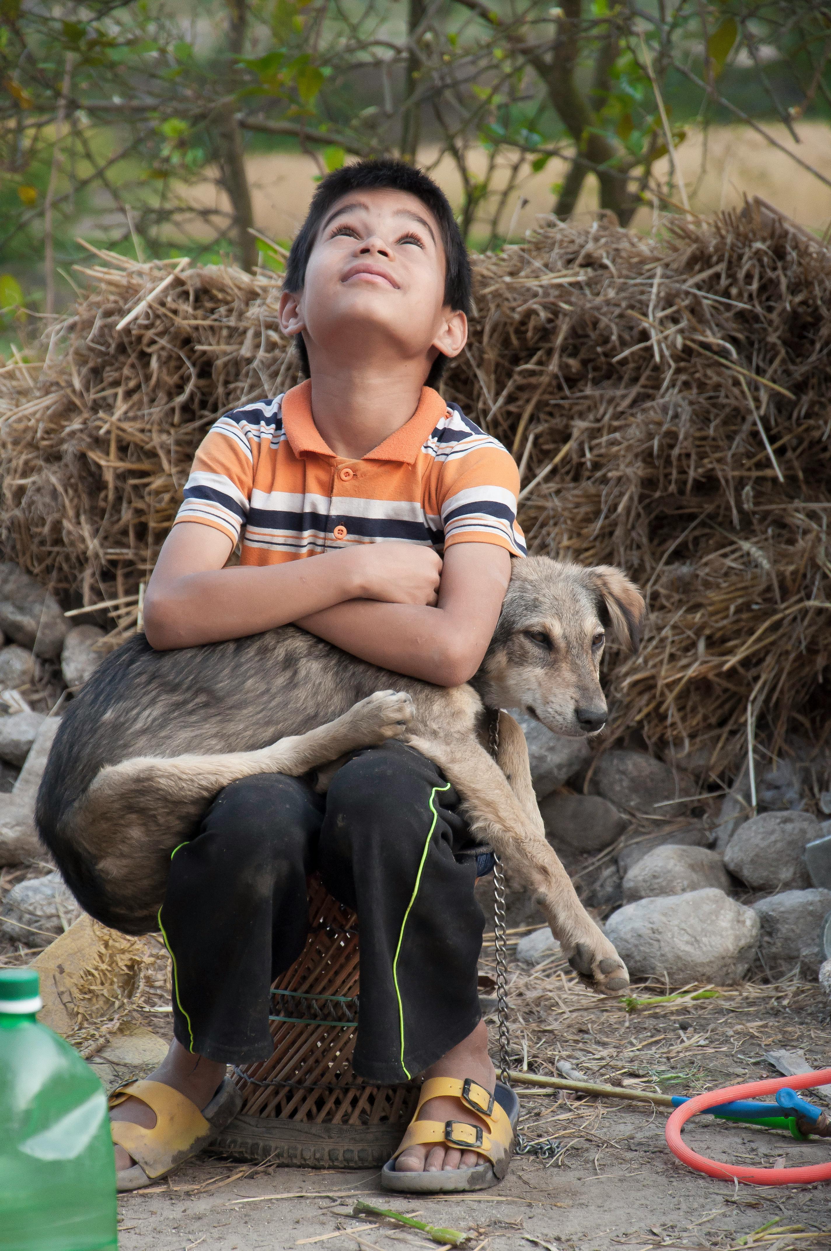 A Boy Wearing a Costume with His Pet Dog · Free Stock Photo