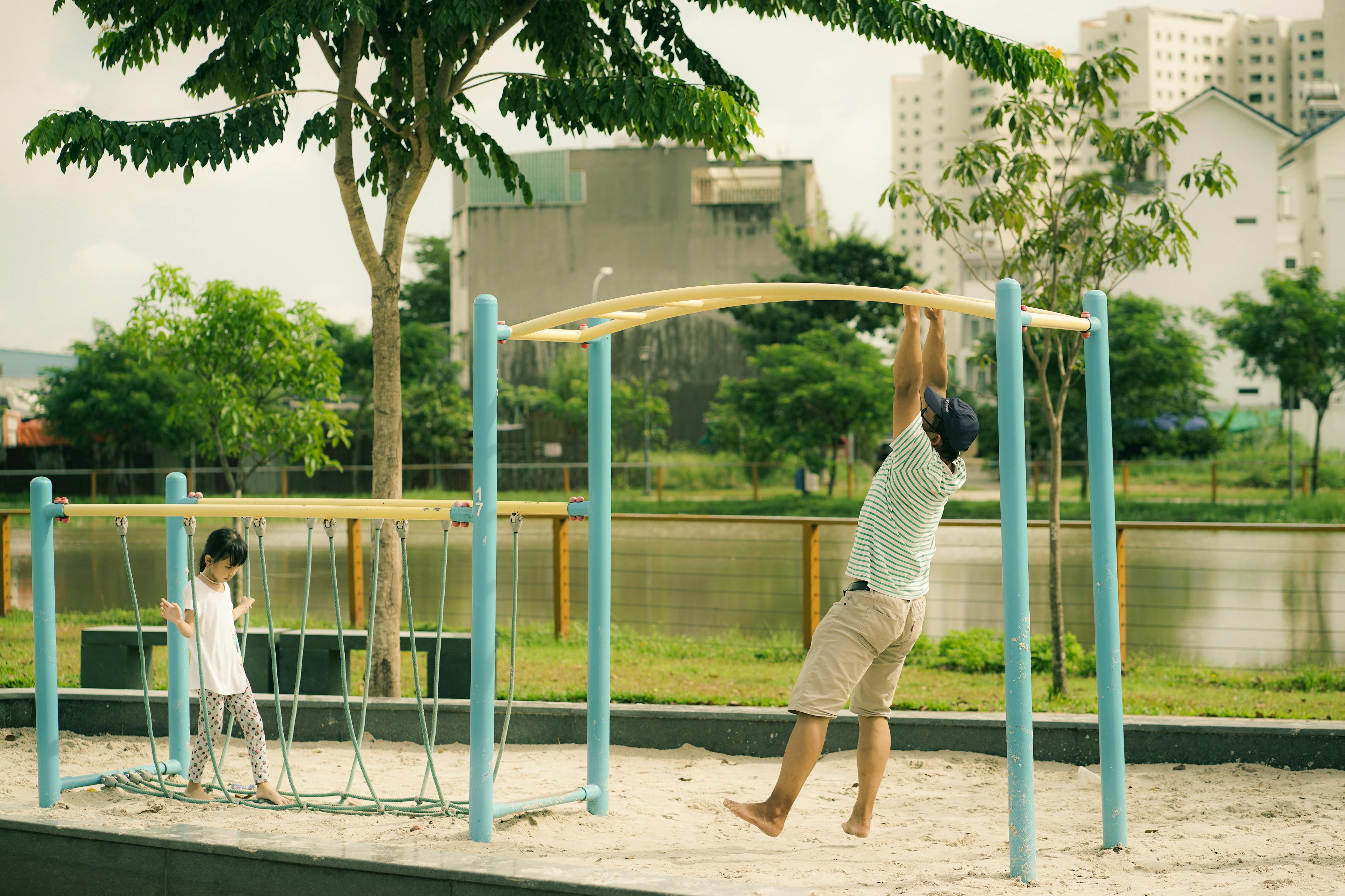 A Man Playing on Monkey Bars · Free Stock Photo