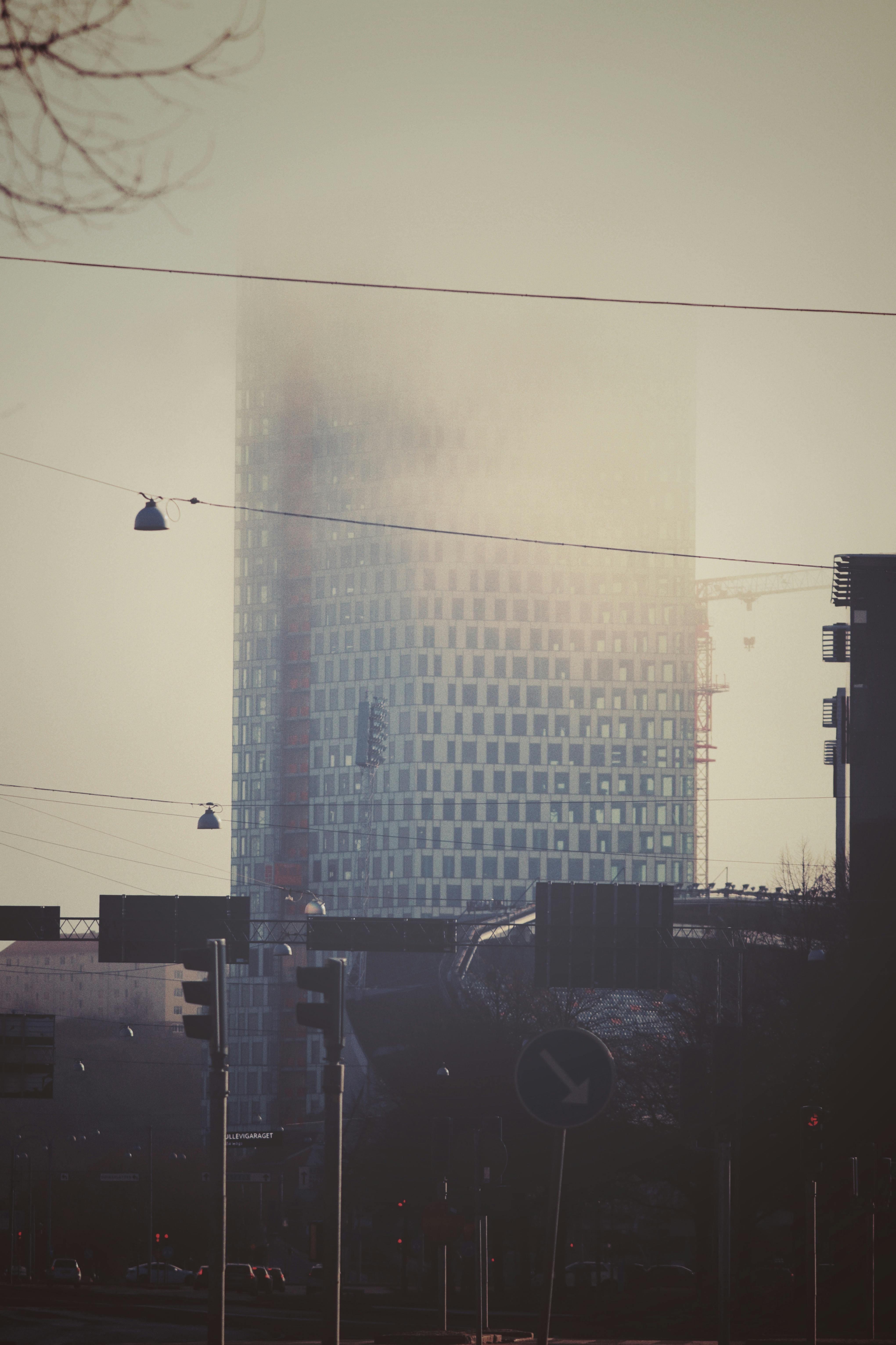 Low-angle Photography of Buildings Covered by Fog · Free Stock Photo
