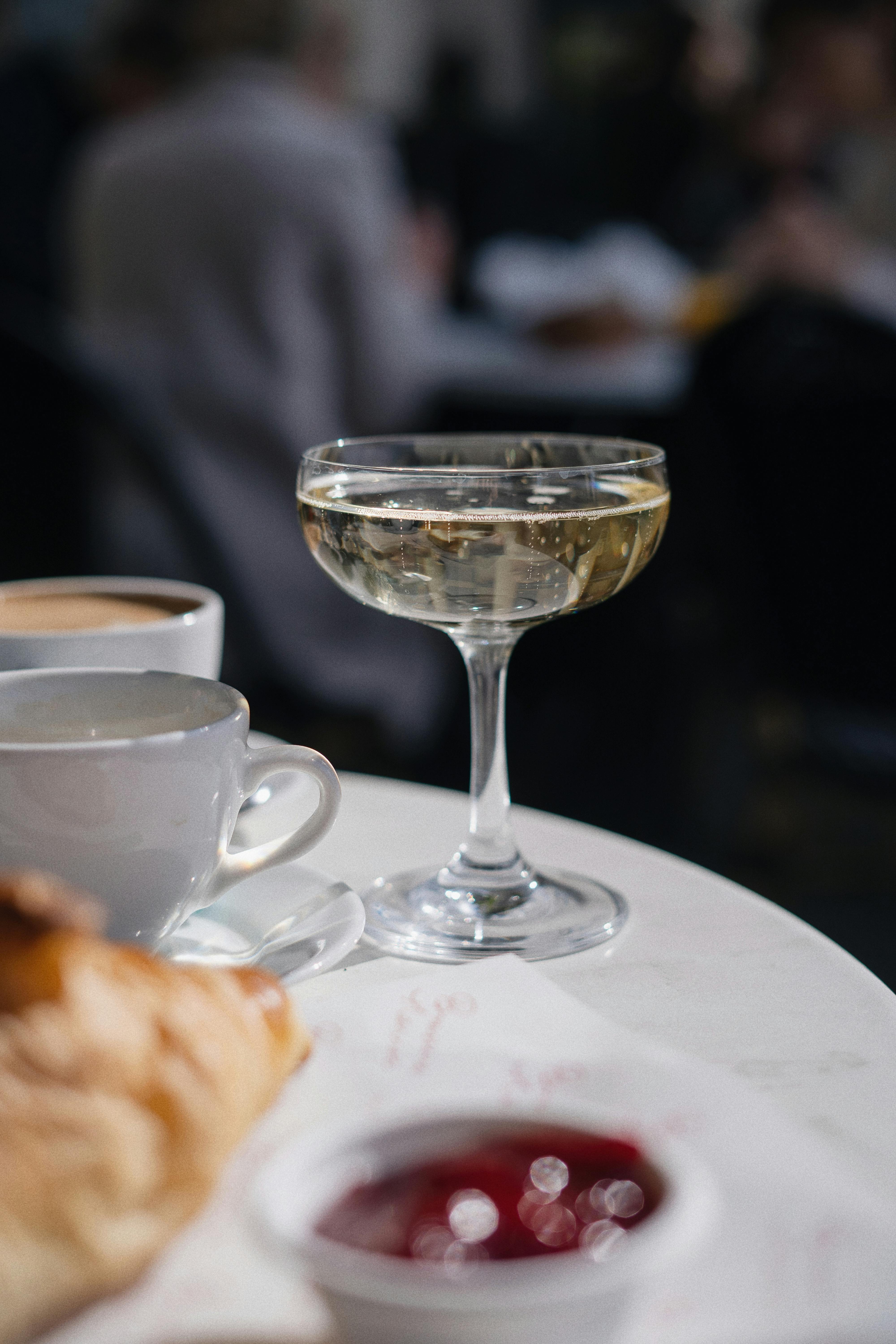Glass of Wine and Food on a Table in a Cafe · Free Stock Photo