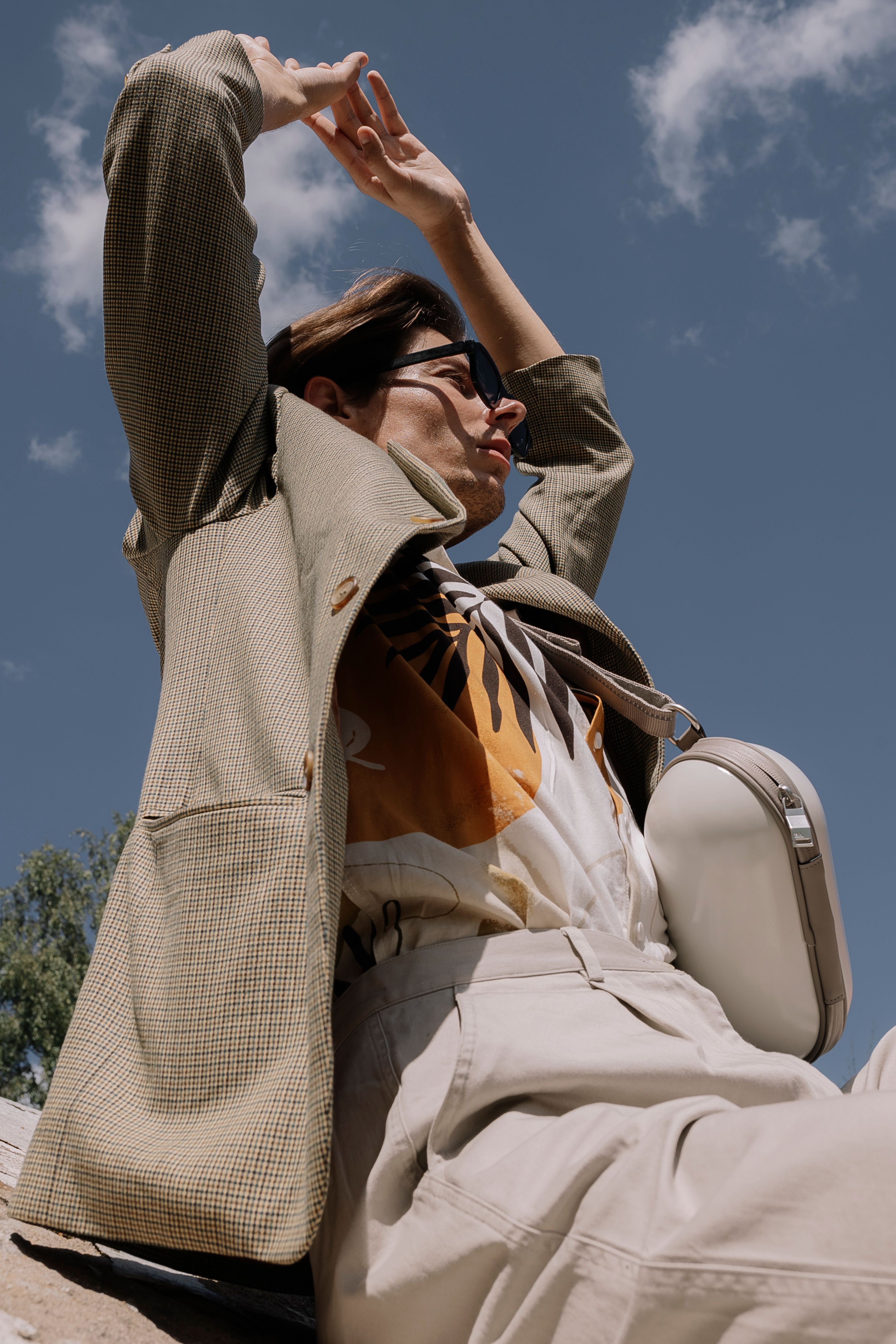 Man in Coat with Arms Raised · Free Stock Photo