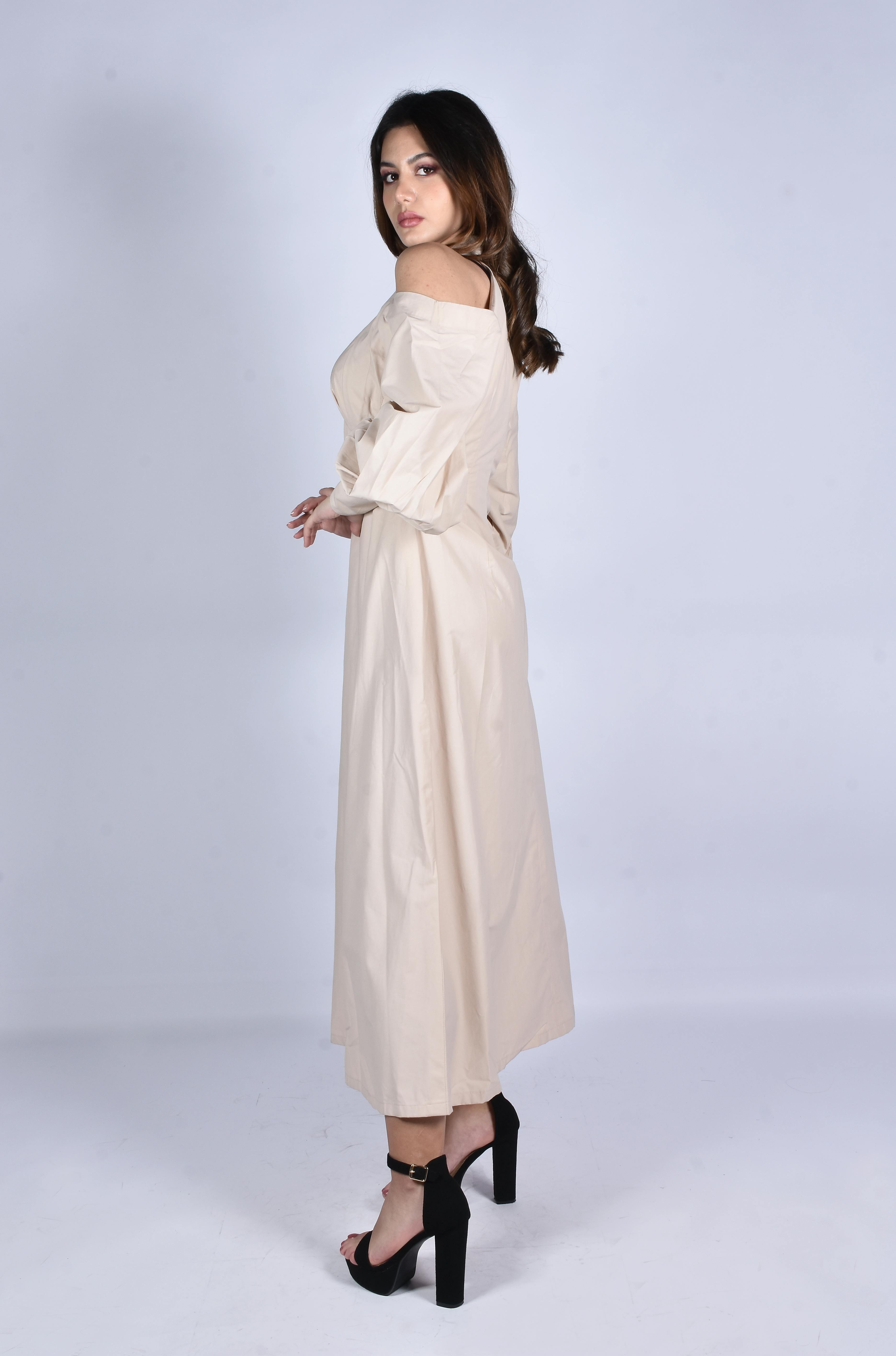 A Model in a Beige Nightie Posing on a Bed · Free Stock Photo