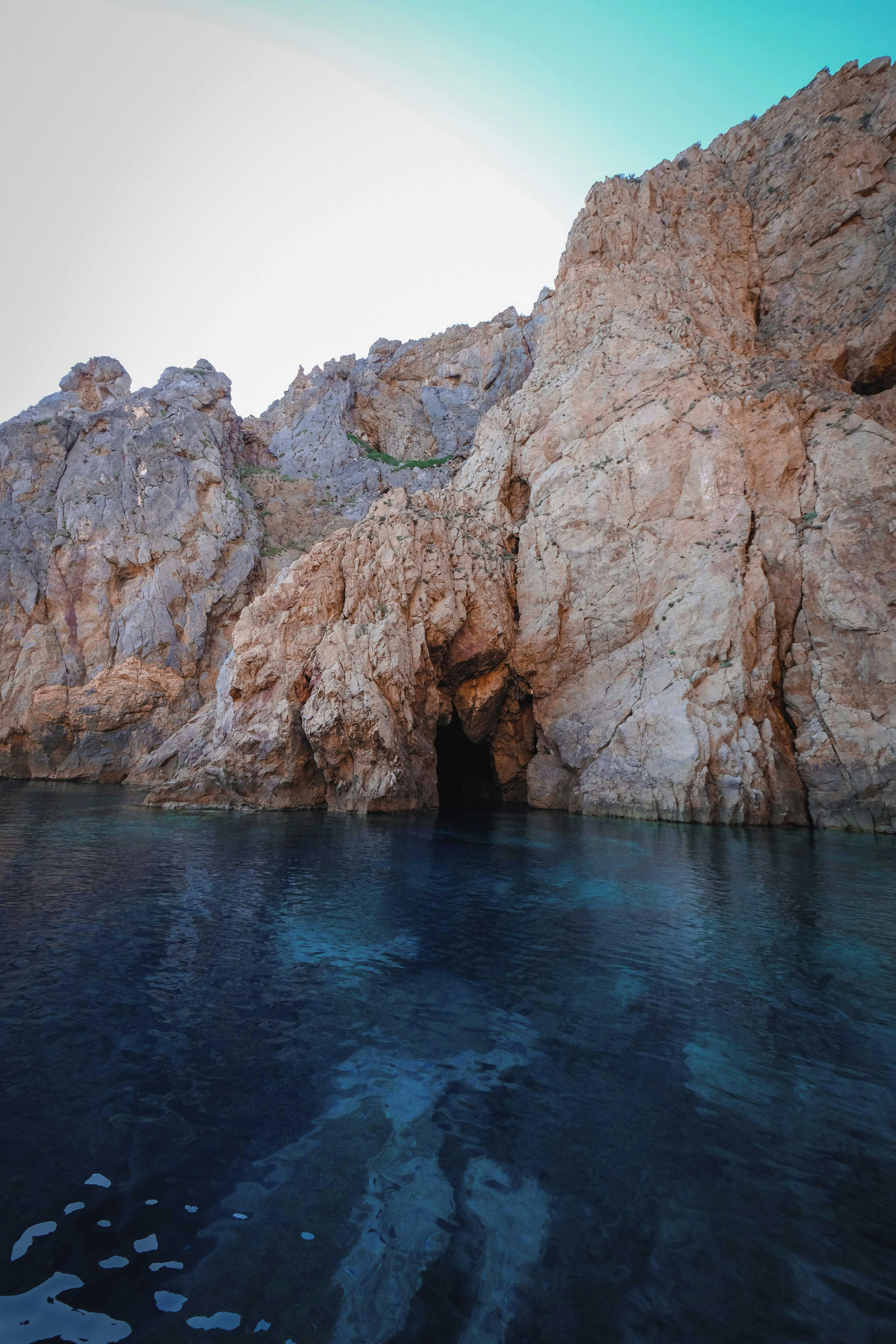 A Rock Formation Near the Sea Under the Clear Sky · Free Stock Photo