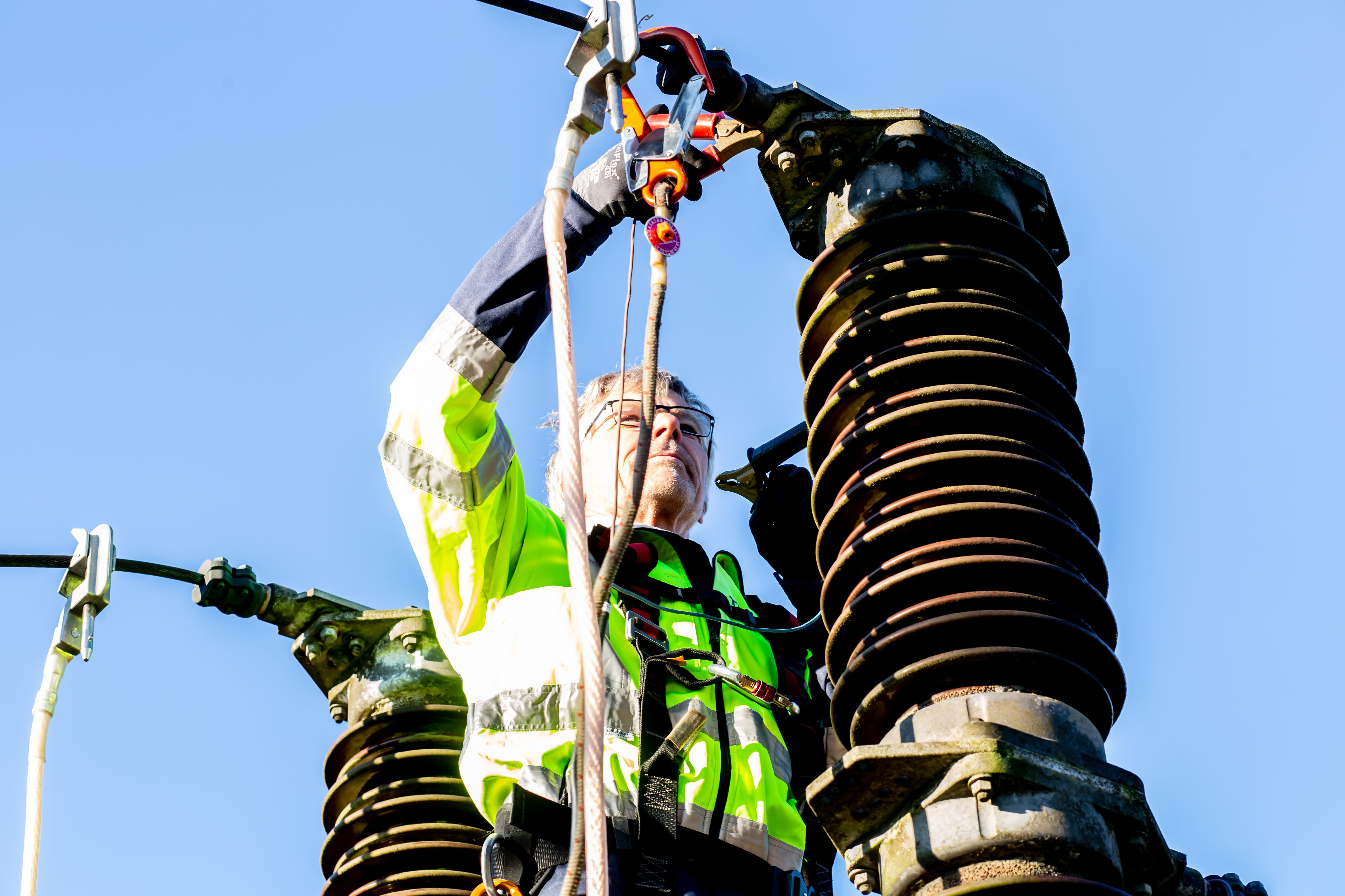 Man Working on an Power Electric Tower · Free Stock Photo