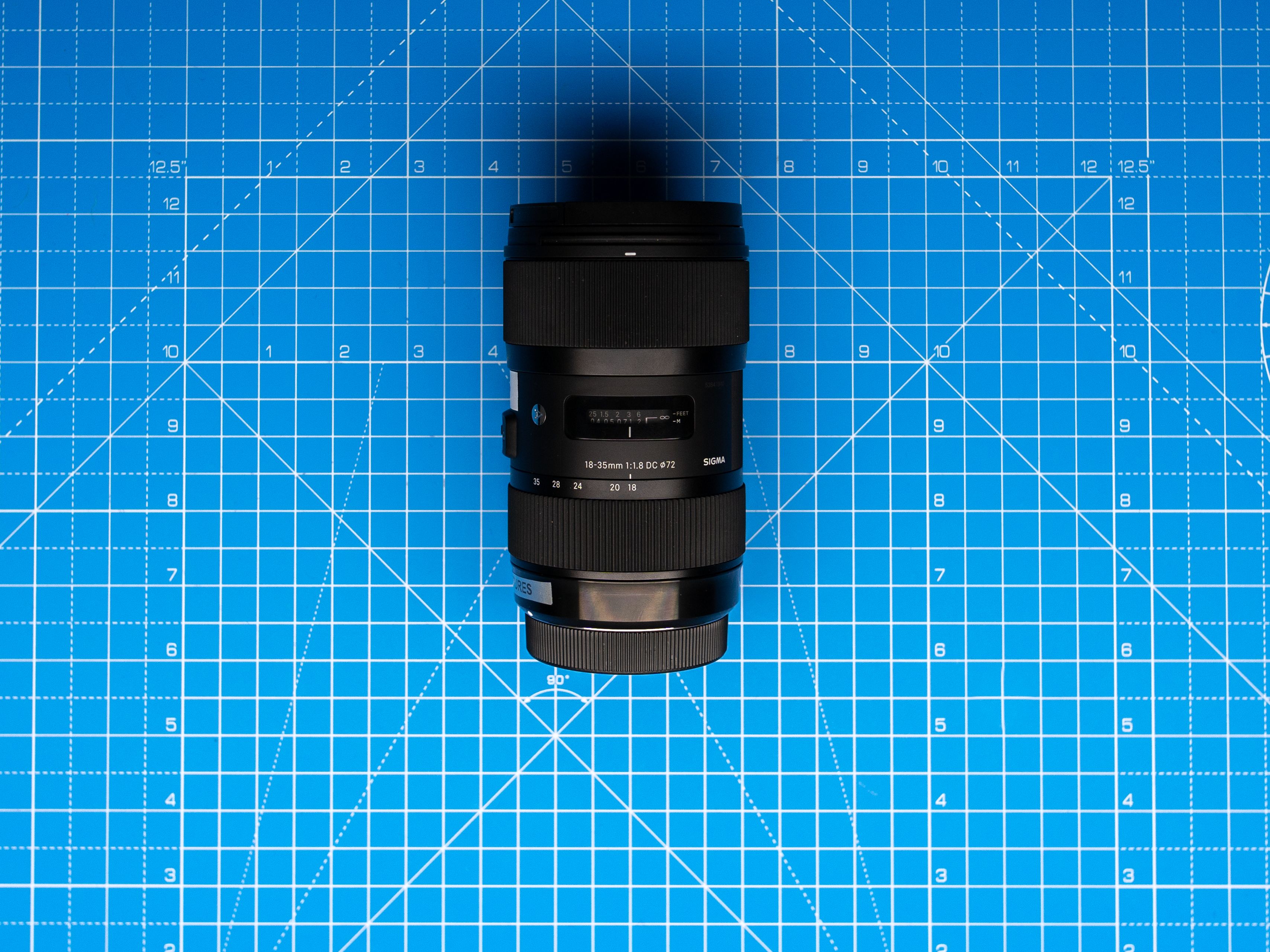 Camera Lens on Blue Cutting Mat · Free Stock Photo