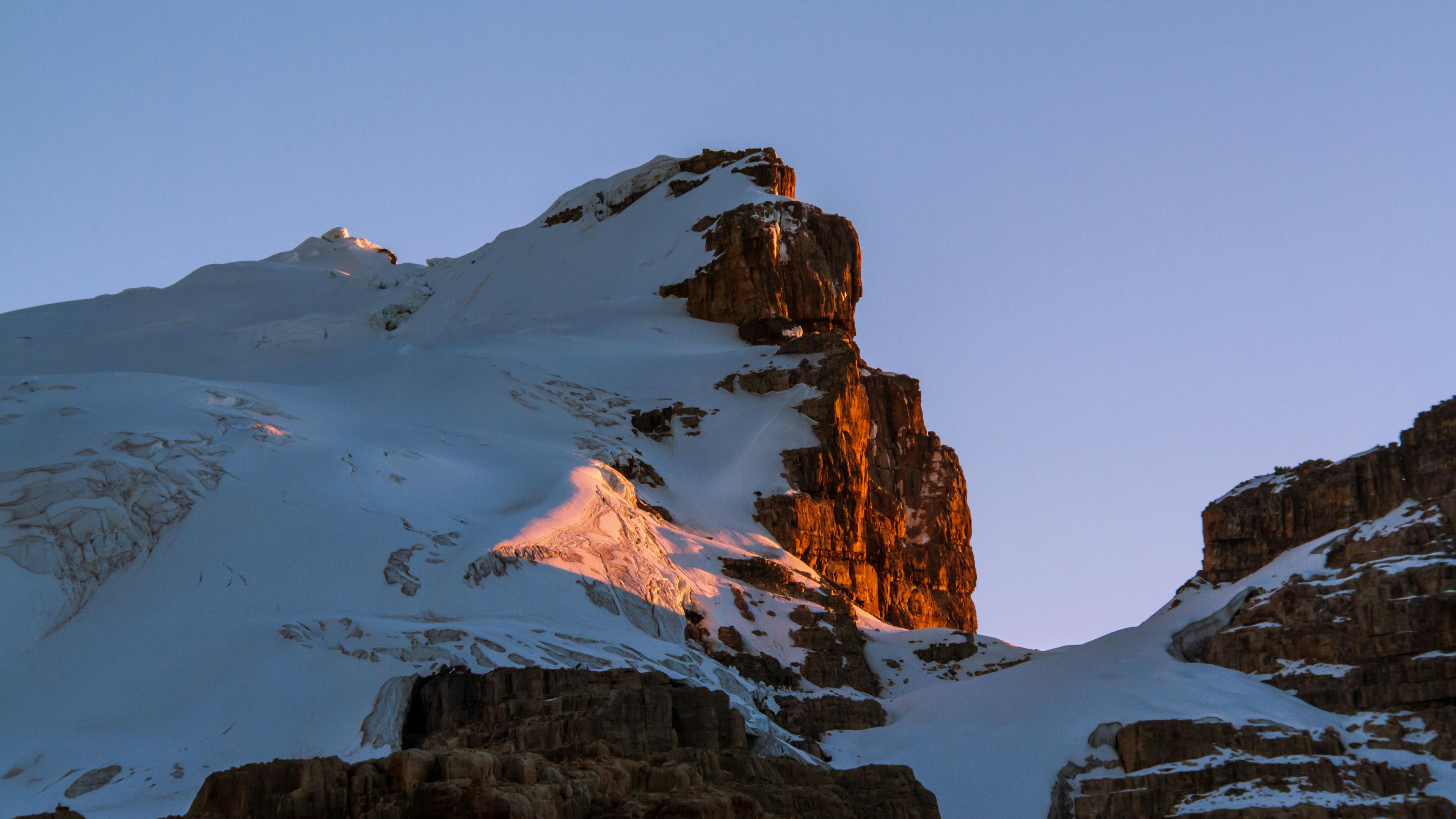 Grey Mountain Filled With Snow Under Grey Sky · Free Stock Photo