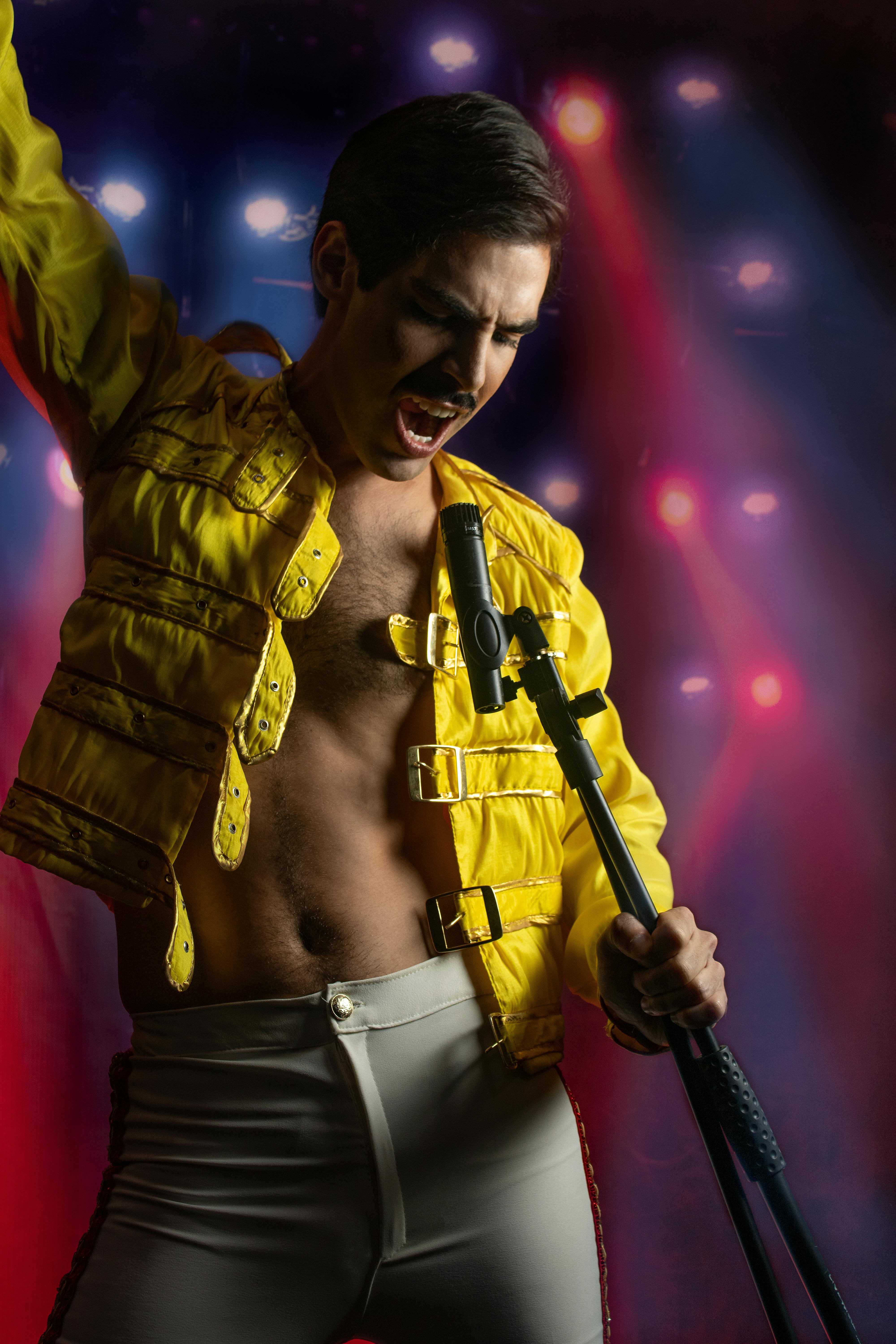 Man in Yellow Jacket Singing · Free Stock Photo