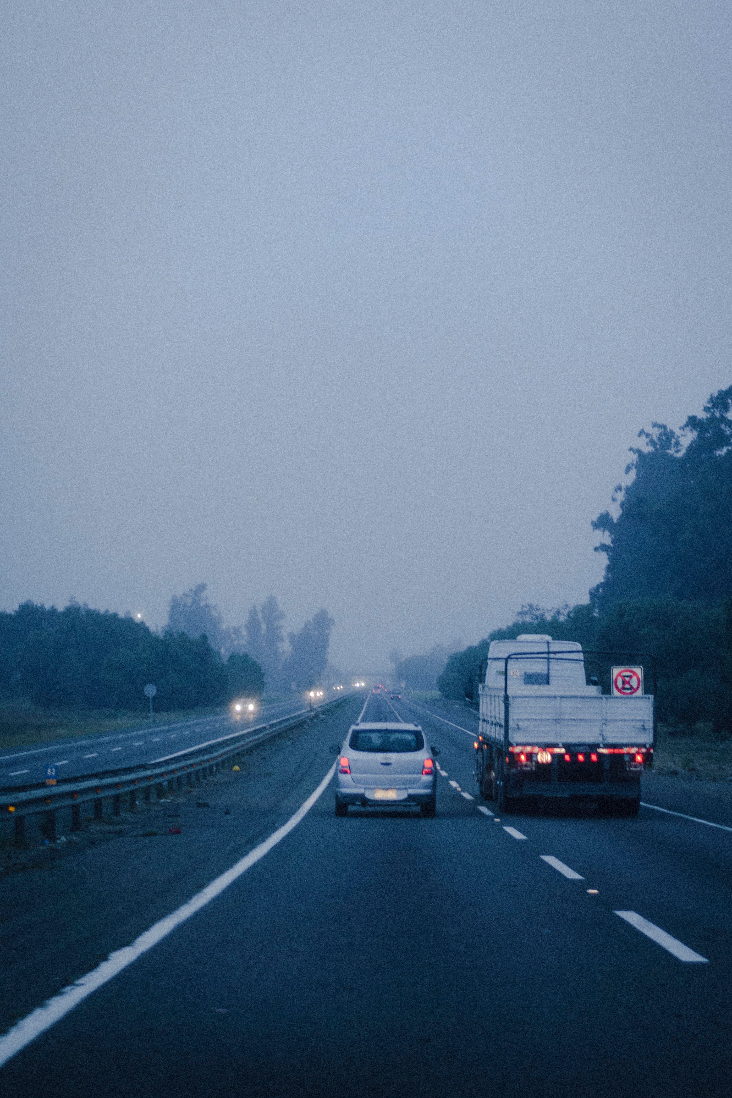 Car Driving beside a Truck · Free Stock Photo