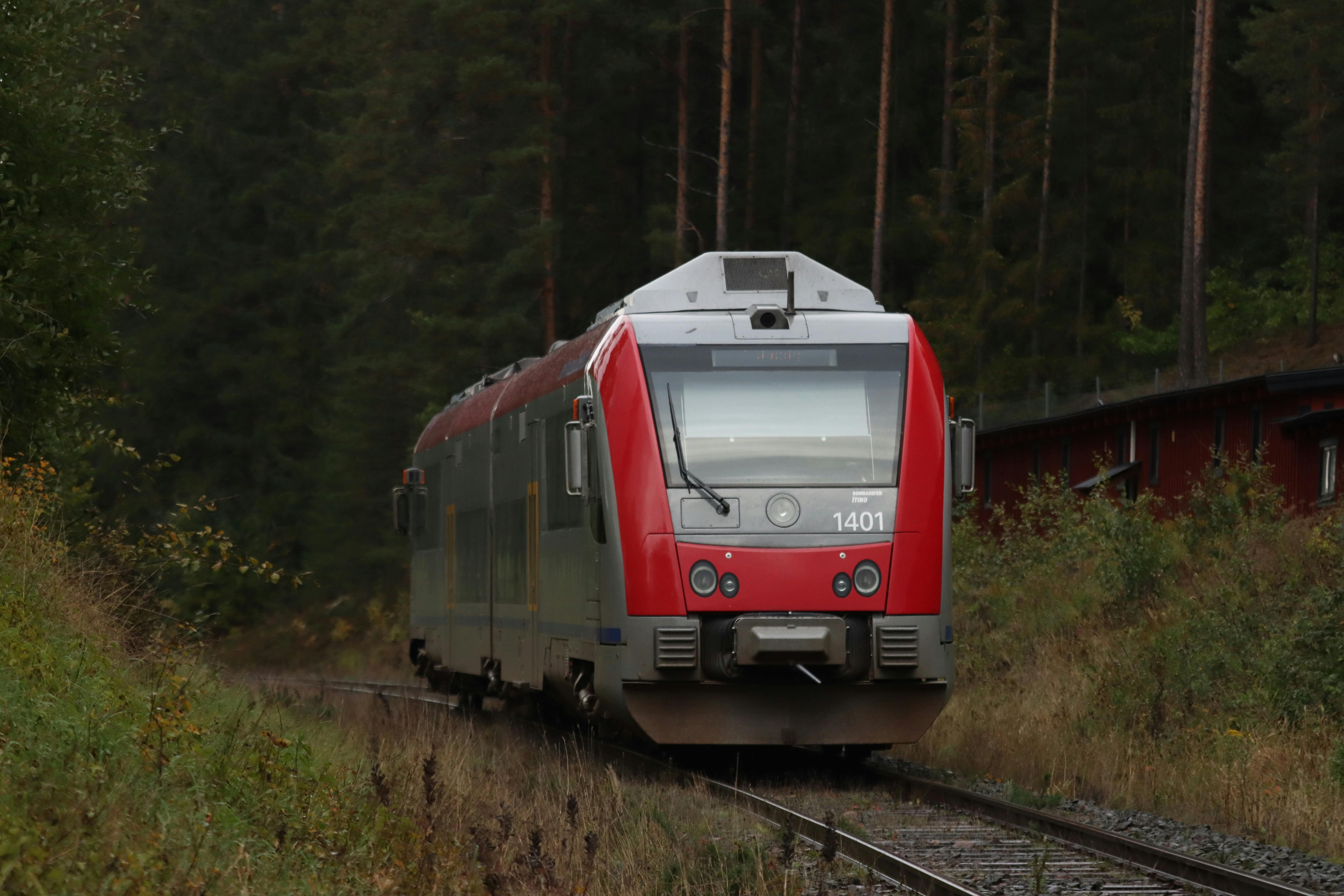 Red and White Train on Rail Tracks · Free Stock Photo