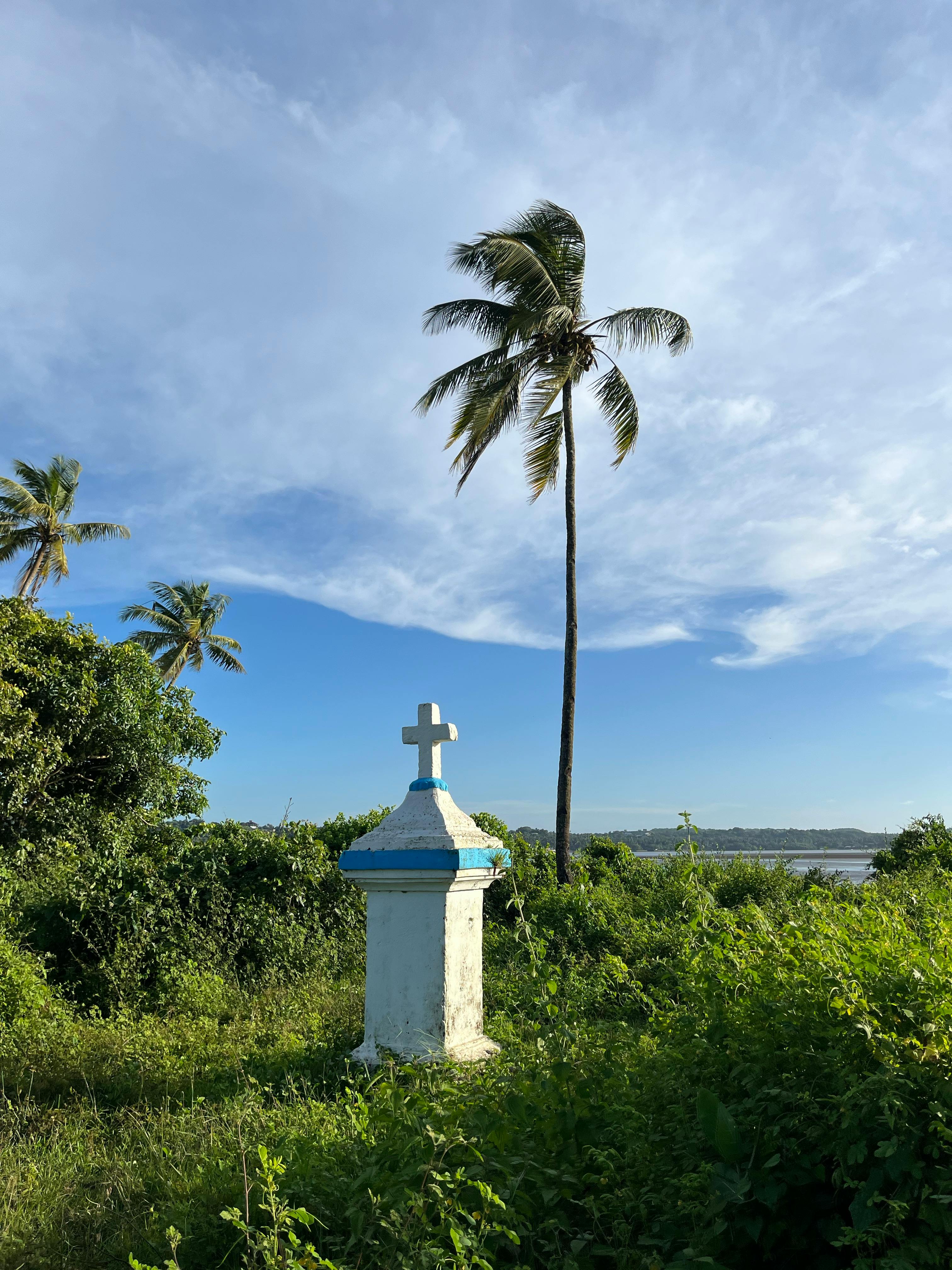 White Cross Statue on Green Grass Field · Free Stock Photo