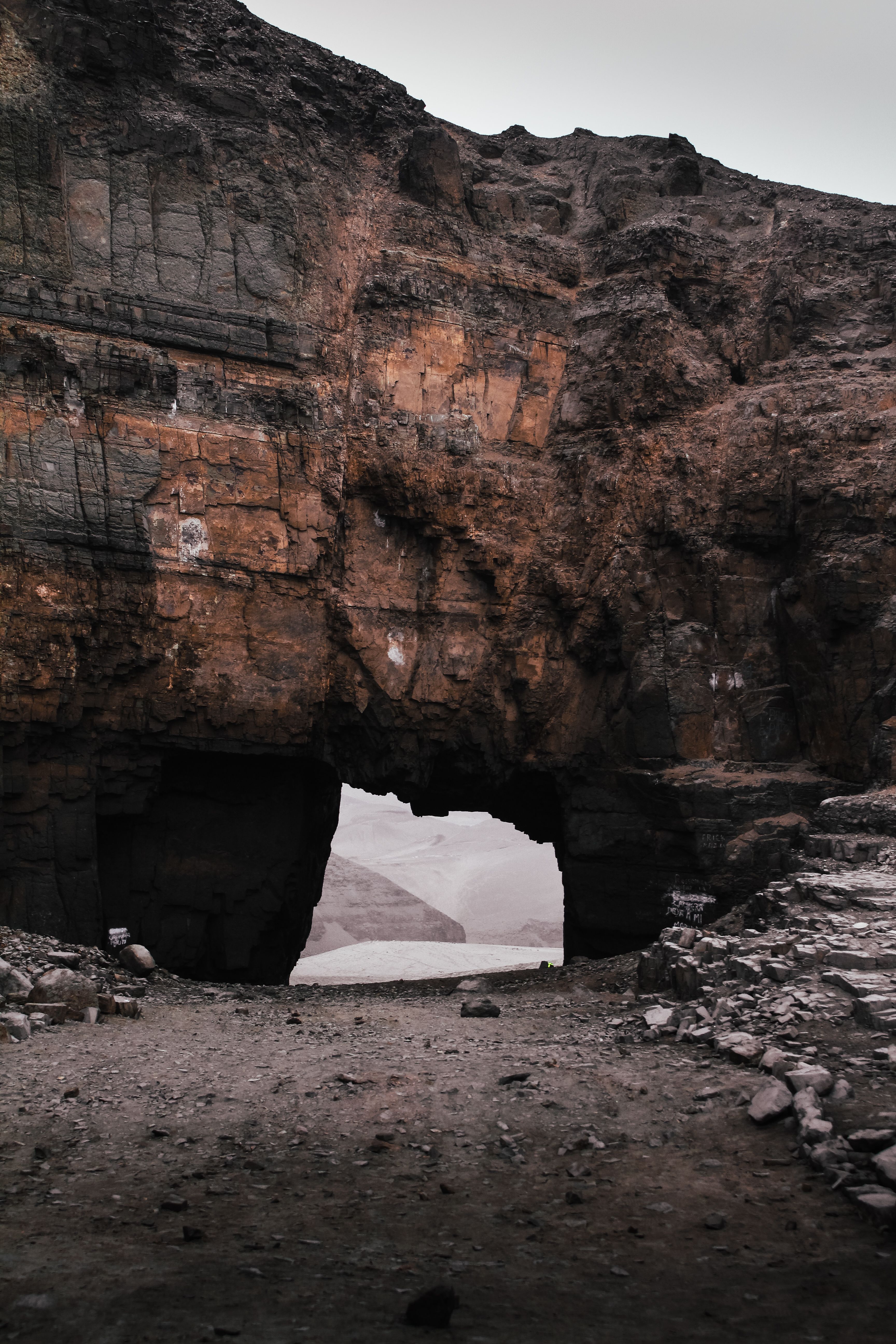 Dirt Road Leading through a Gap in a Rock · Free Stock Photo