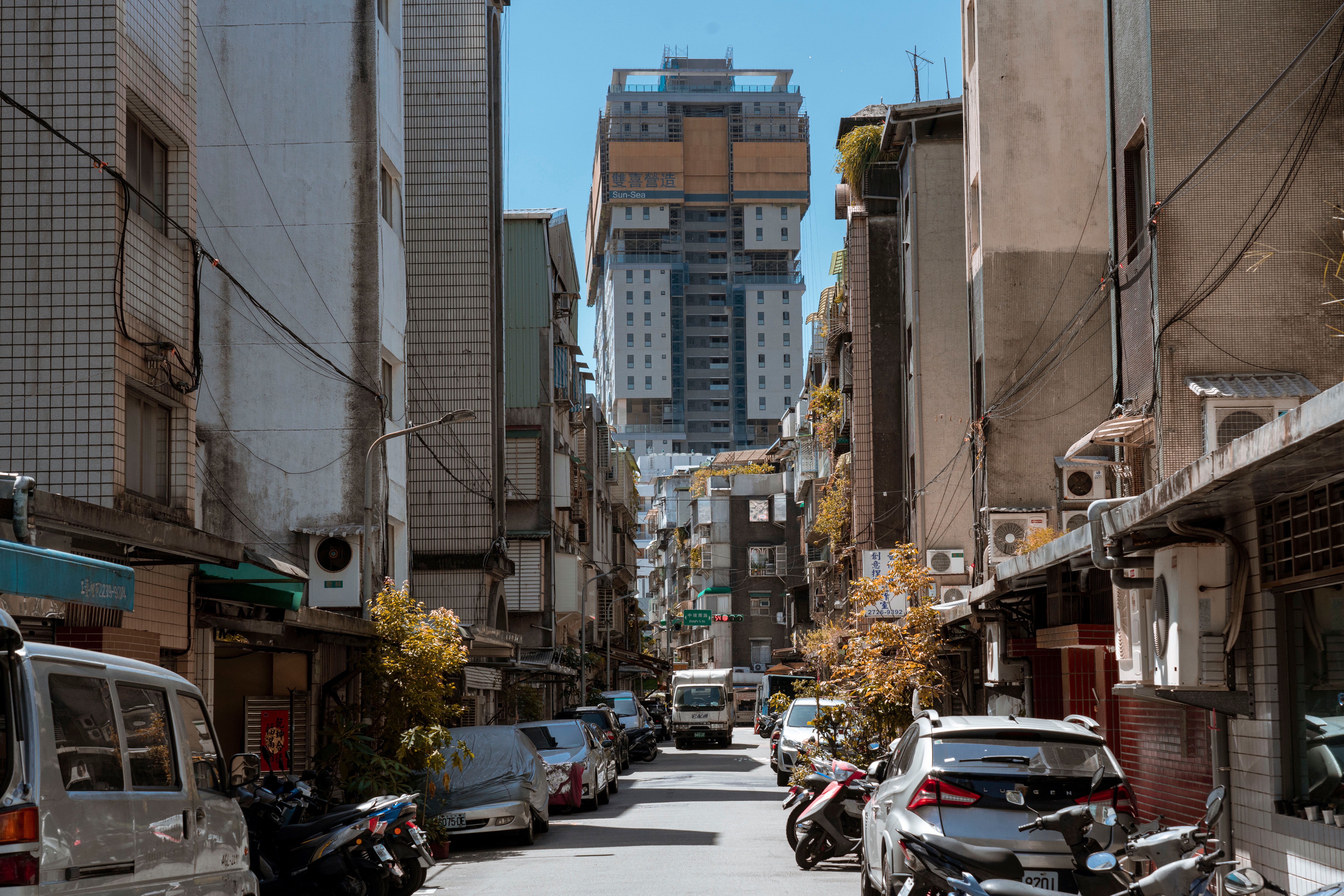 Cars Parked on Side of the Road in Between High Rise Buildings · Free ...
