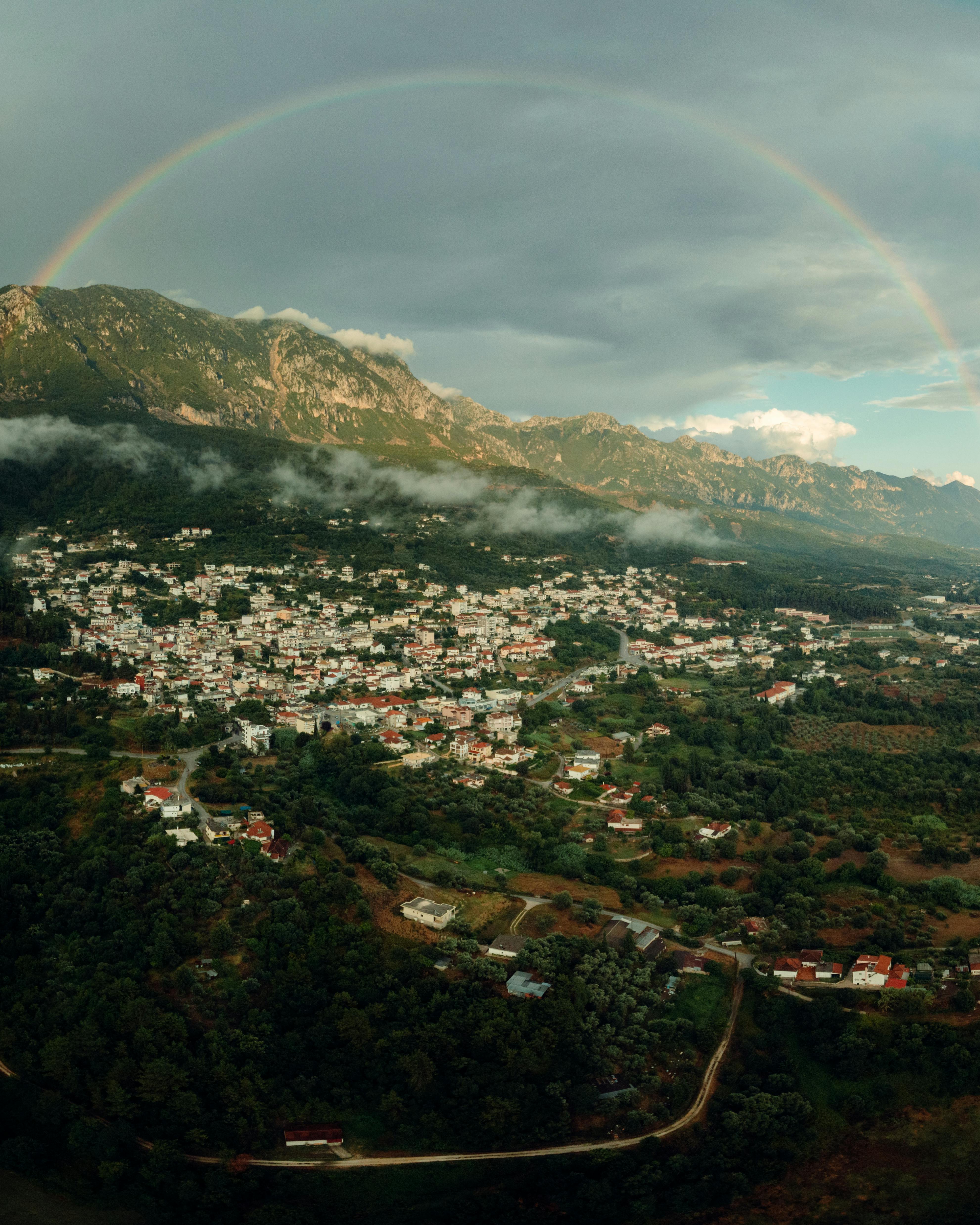 Photograph of a Rainbow Starting on a Hill · Free Stock Photo
