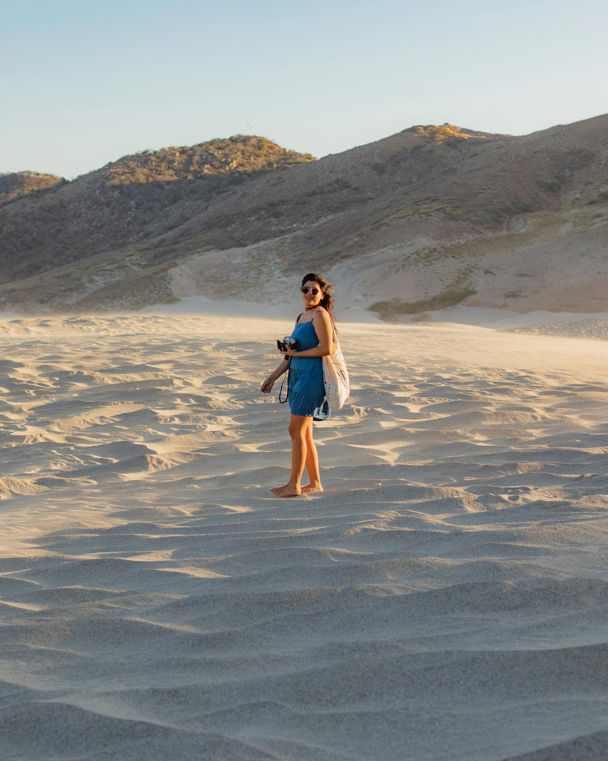 A Woman Standing on the Sand · Free Stock Photo