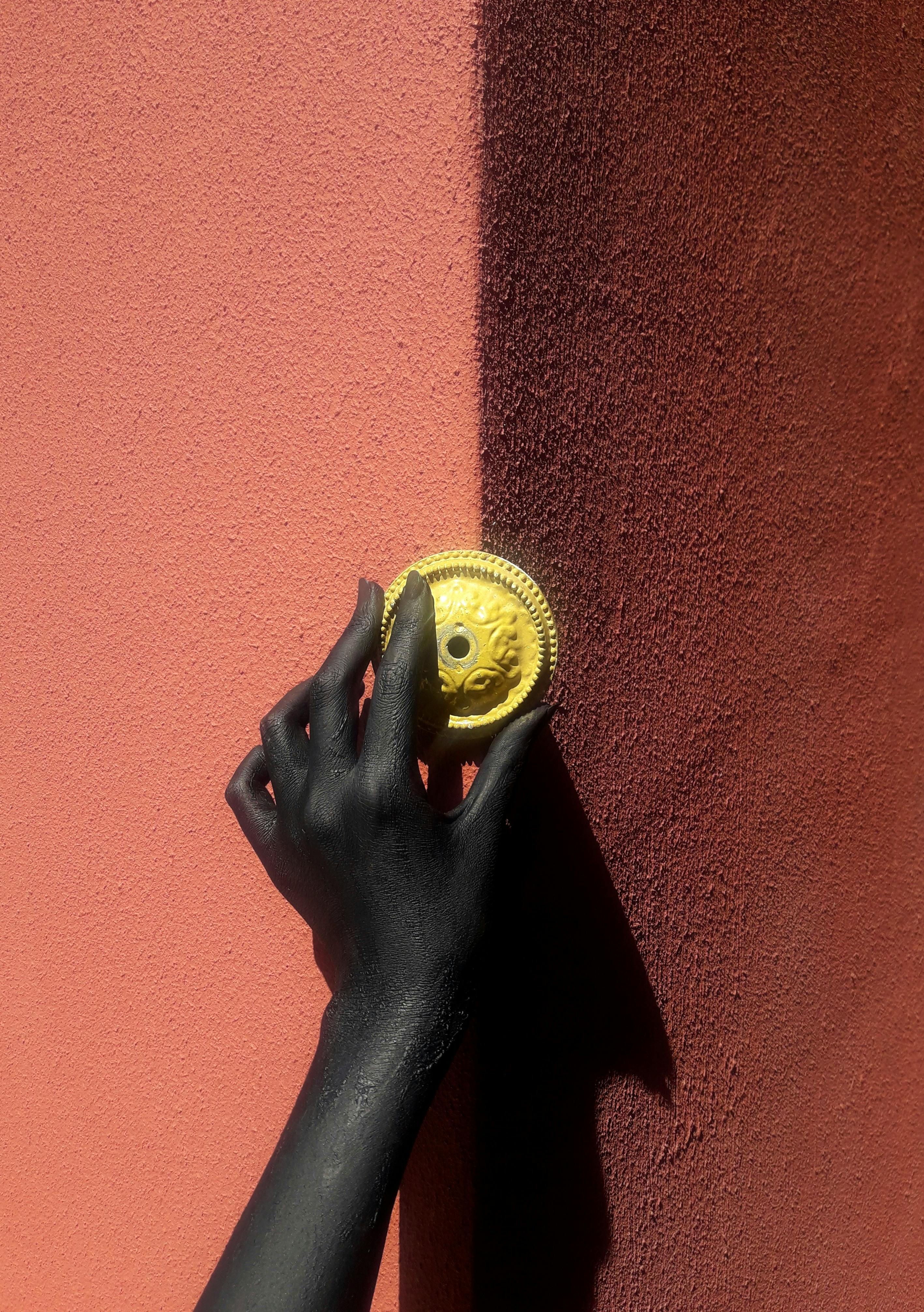 Hand Holding Item on Wall · Free Stock Photo