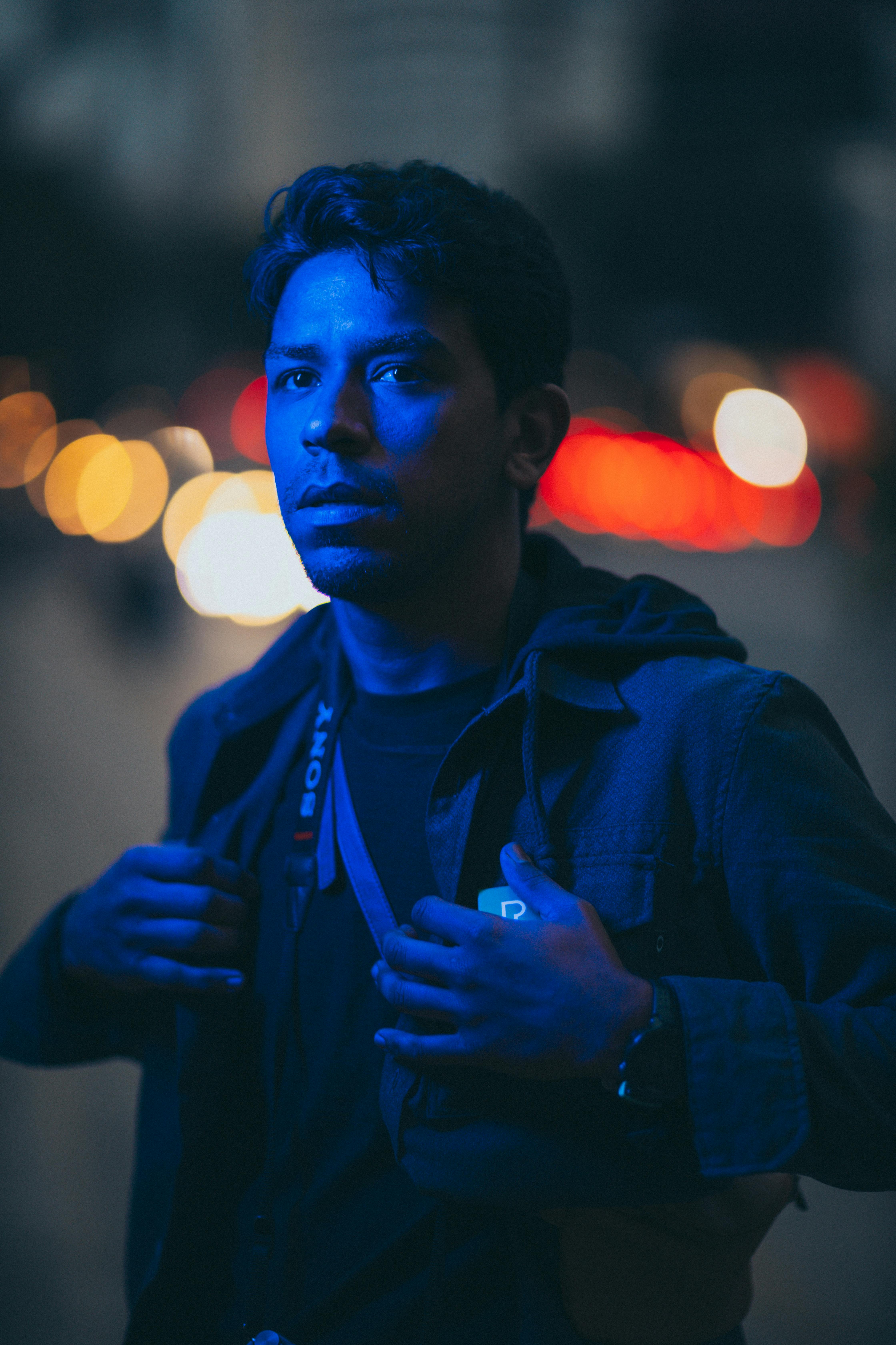 Blue Light Reflection on Man in Blue Jacket · Free Stock Photo