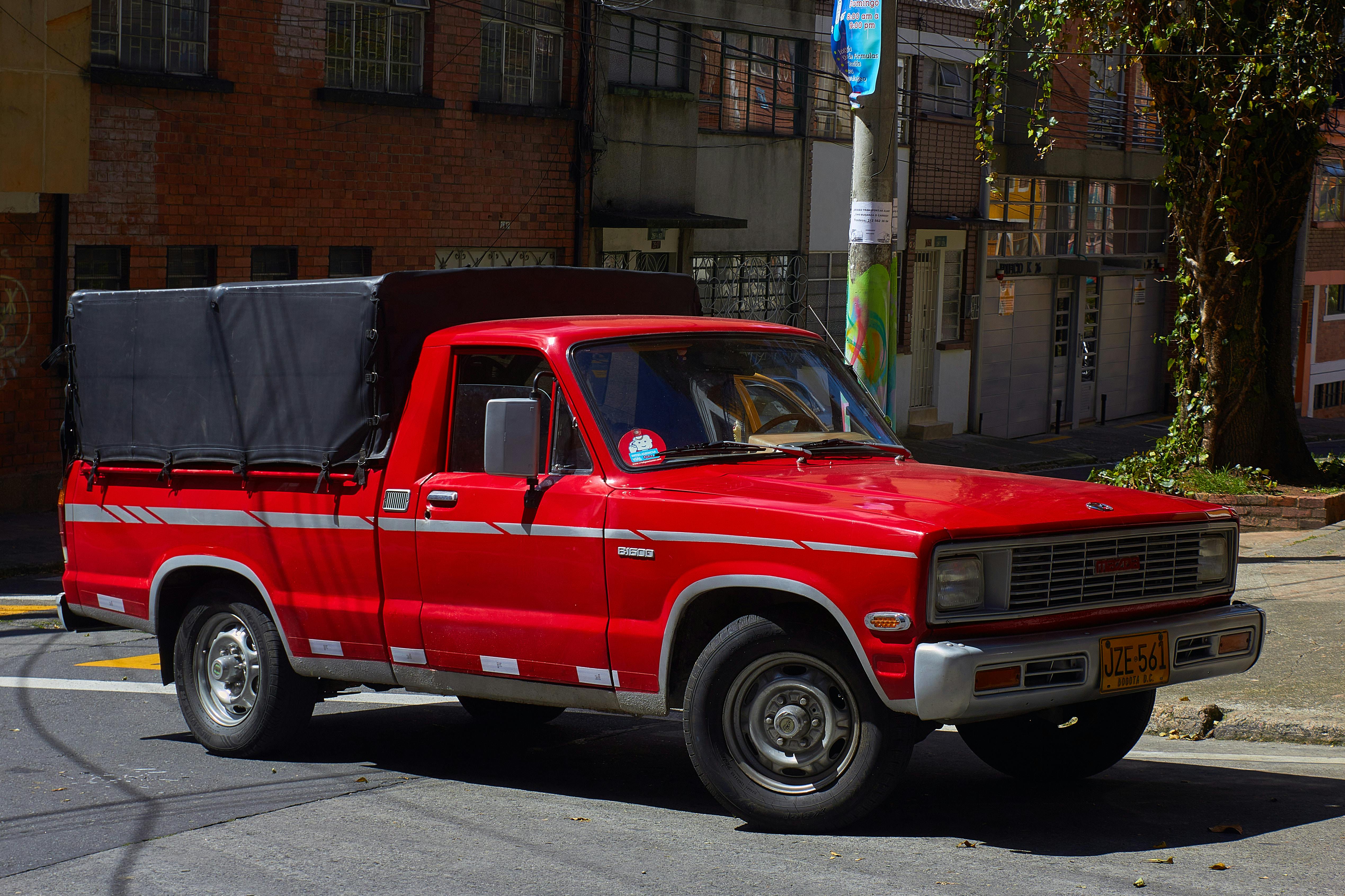 A Red Pickup Truck on the Road · Free Stock Photo