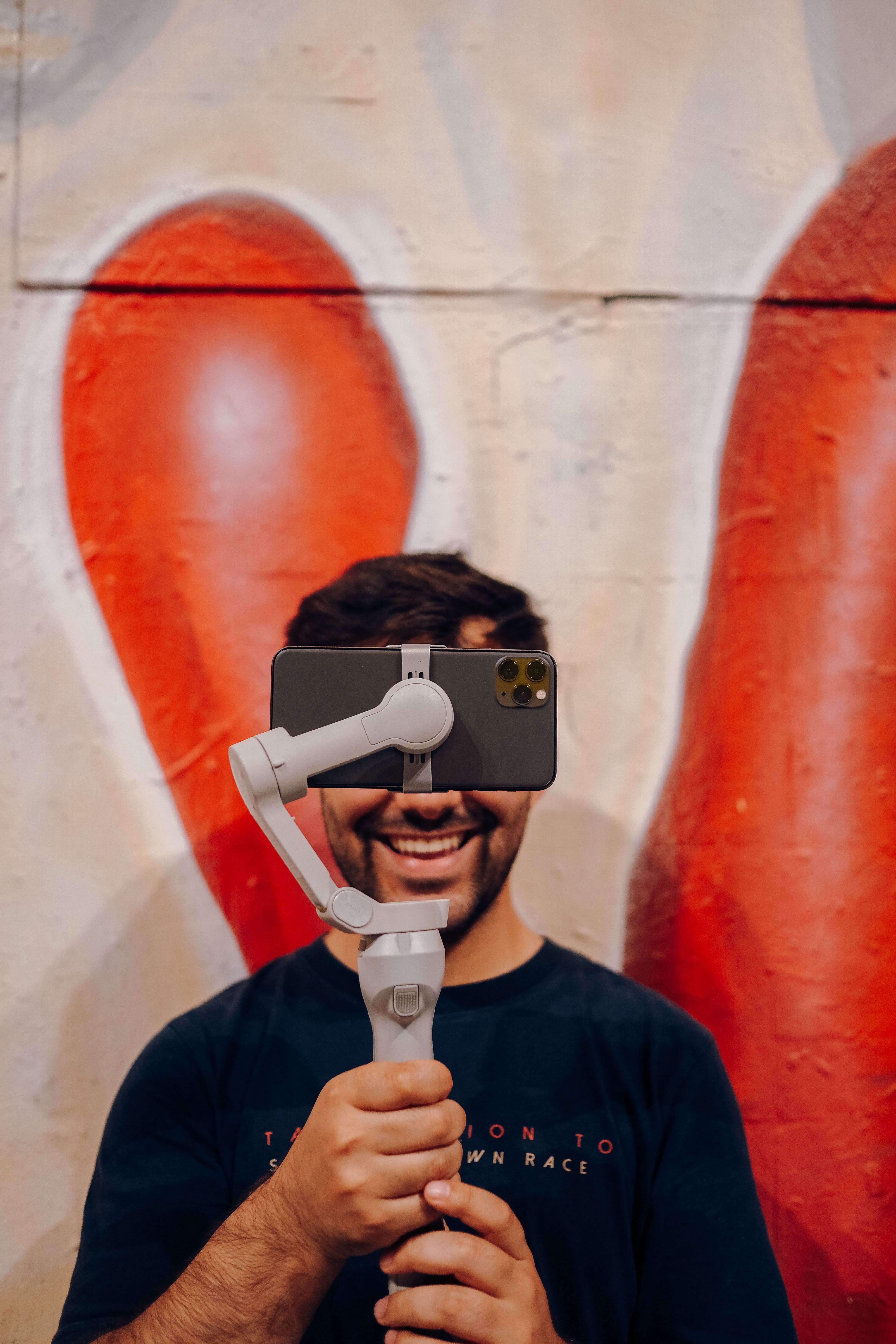 A Person Holding a Gimbal with an Attached Smartphone · Free Stock Photo