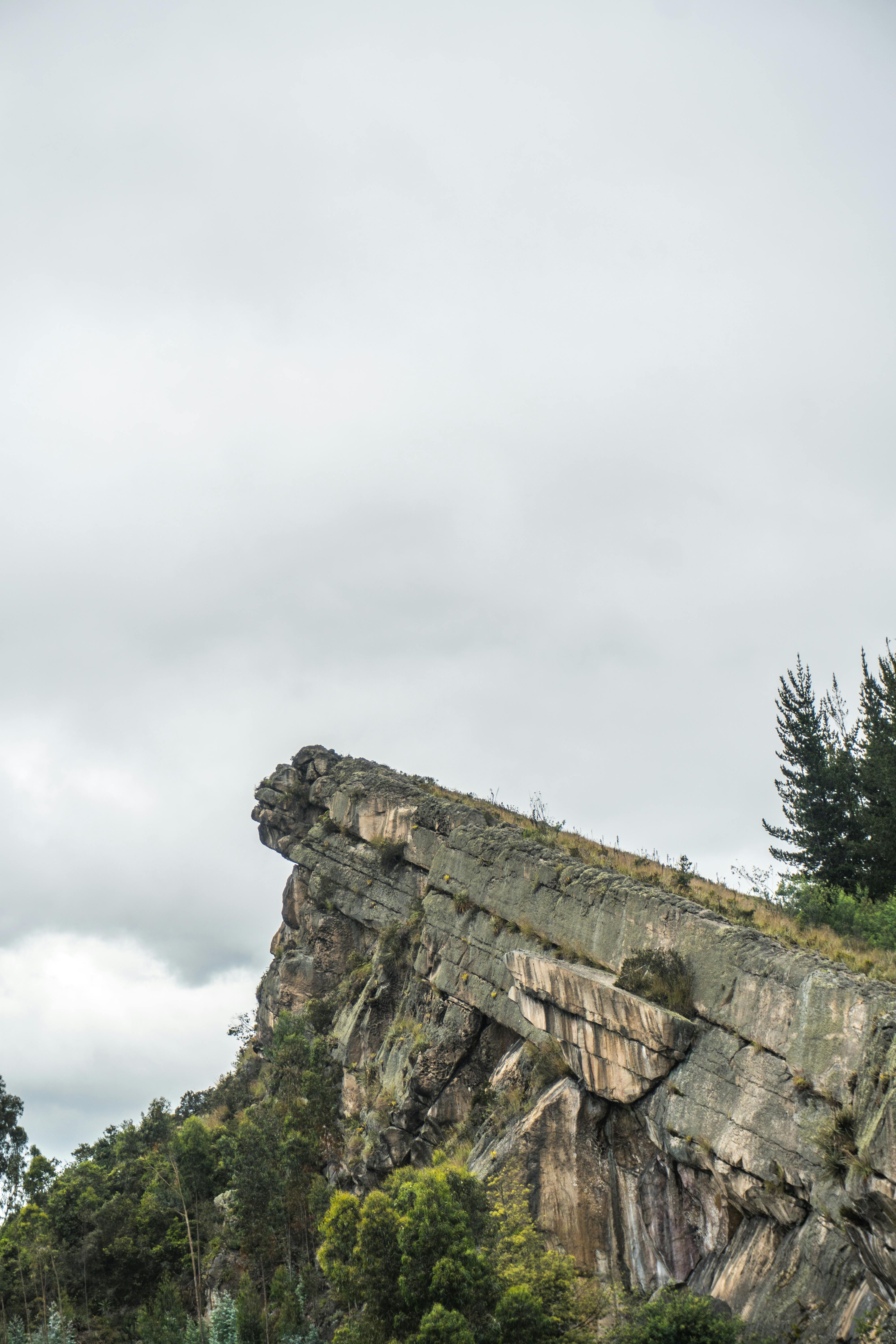 Gray Rock Formation under Gloomy Sky · Free Stock Photo