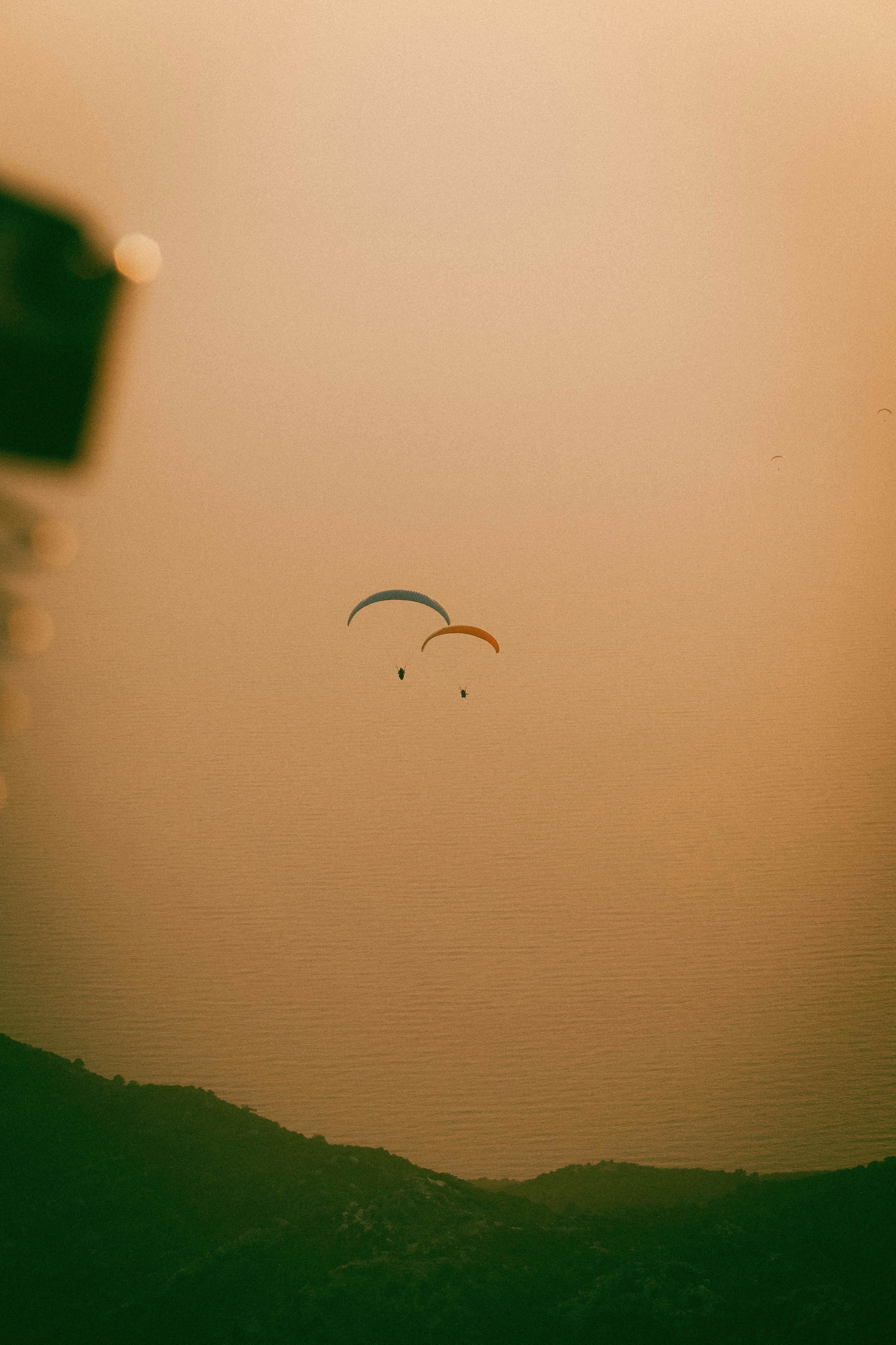 Panorama Photo of a Person Parachuting Above Volcano Lake during ...