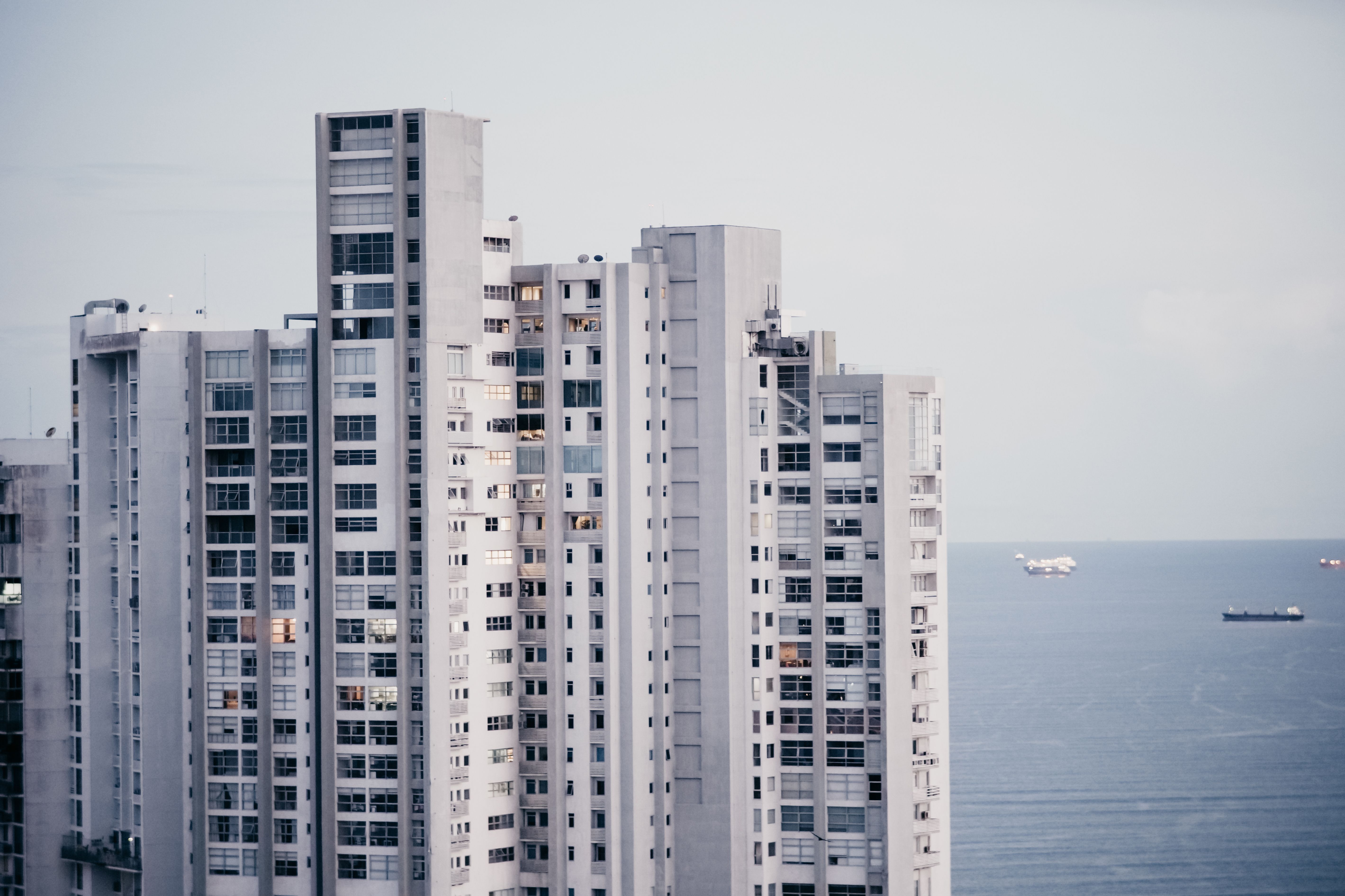 White Concrete Buildings Near Body of Water · Free Stock Photo