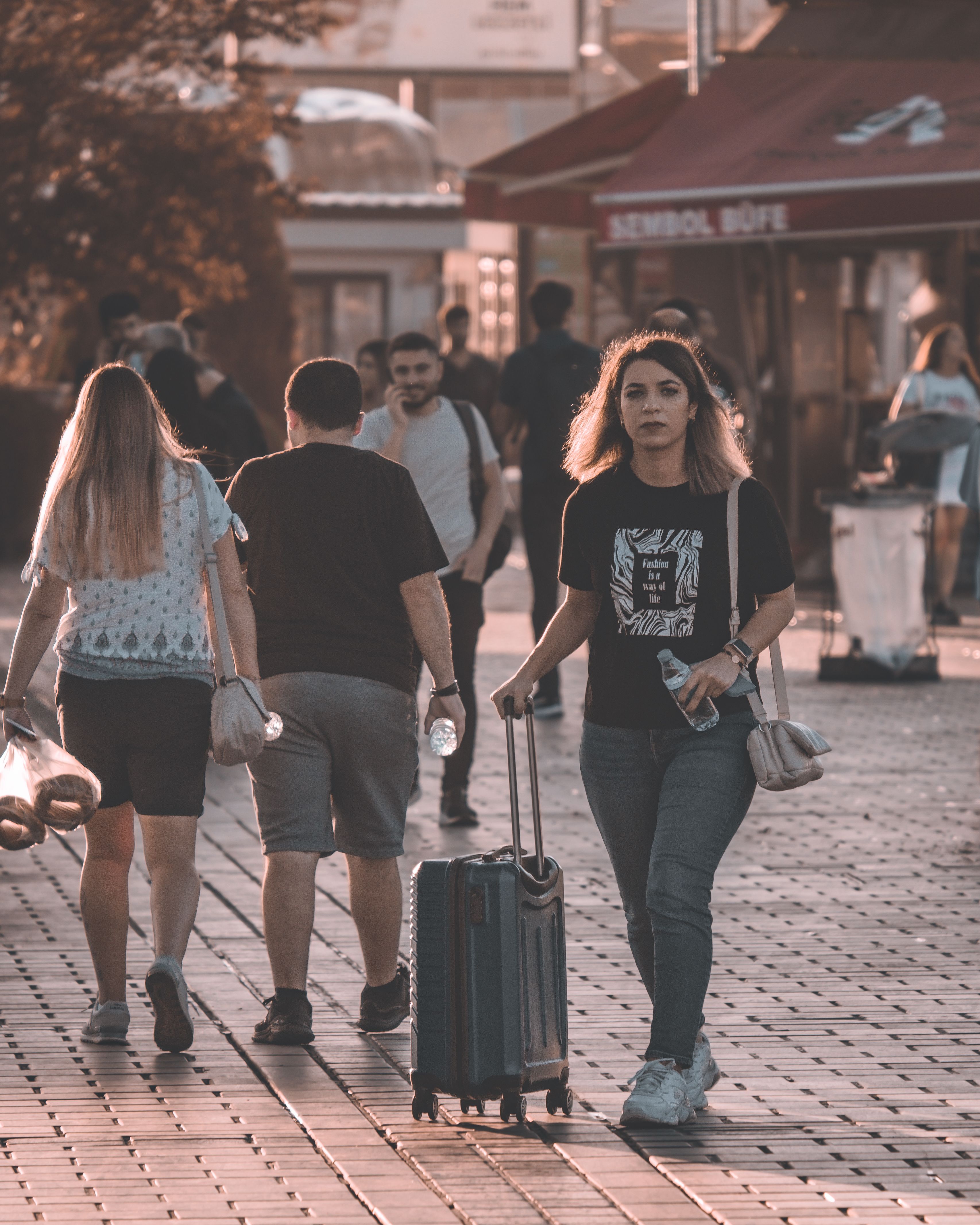 Woman with Suitcase on City Street · Free Stock Photo