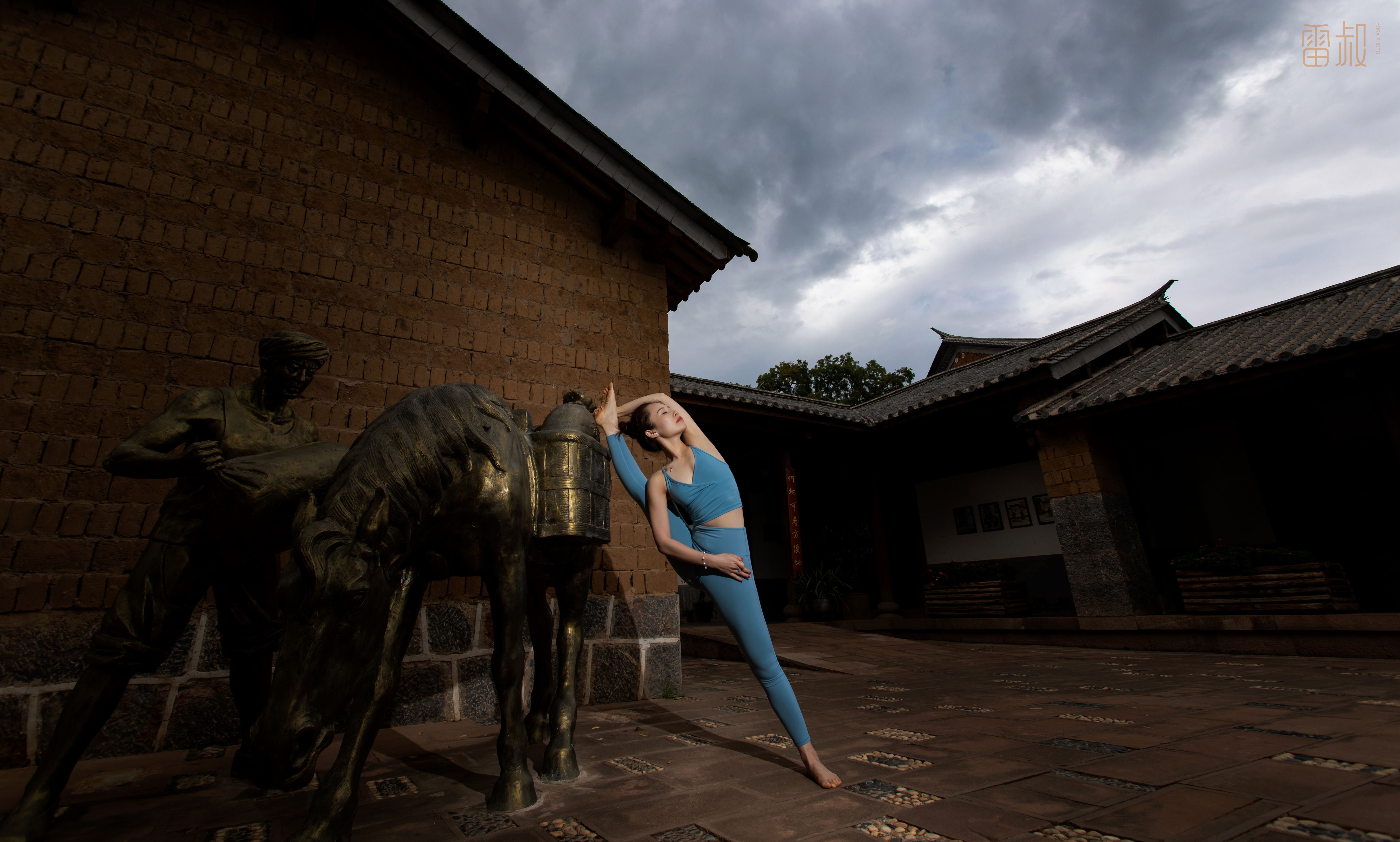 Woman Leaning on a Statue while Doing a Leg Spit · Free Stock Photo