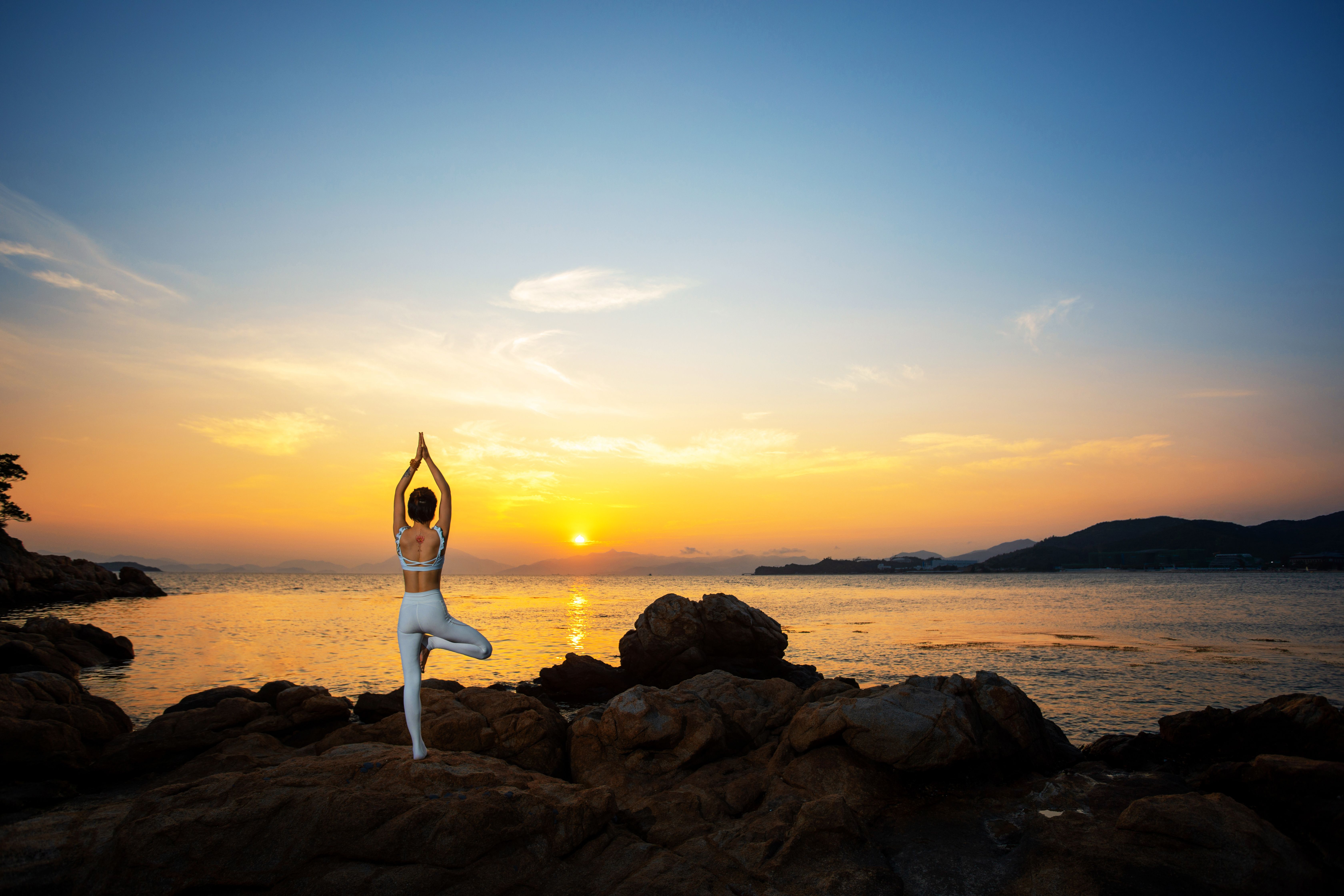 A Woman Doing Yoga on the Rocks · Free Stock Photo