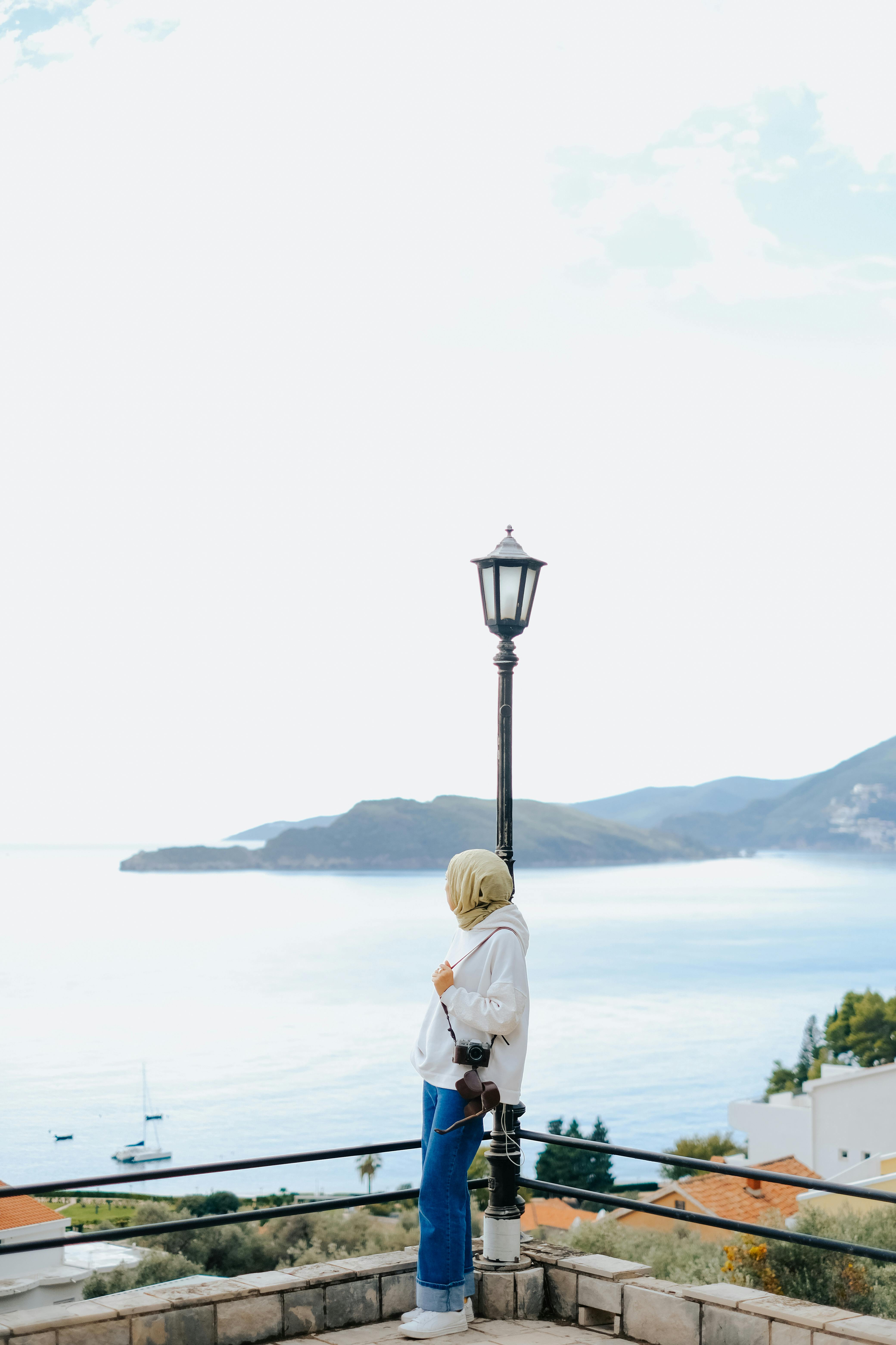 Woman Leaning on a Lamp Post · Free Stock Photo